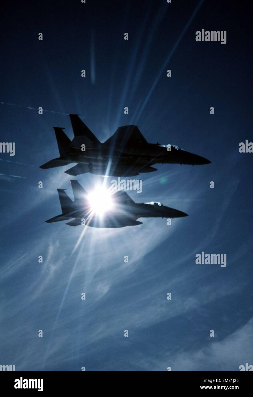 Air-to-air right side view of two F-15 Eagle fighter aircraft from the ...