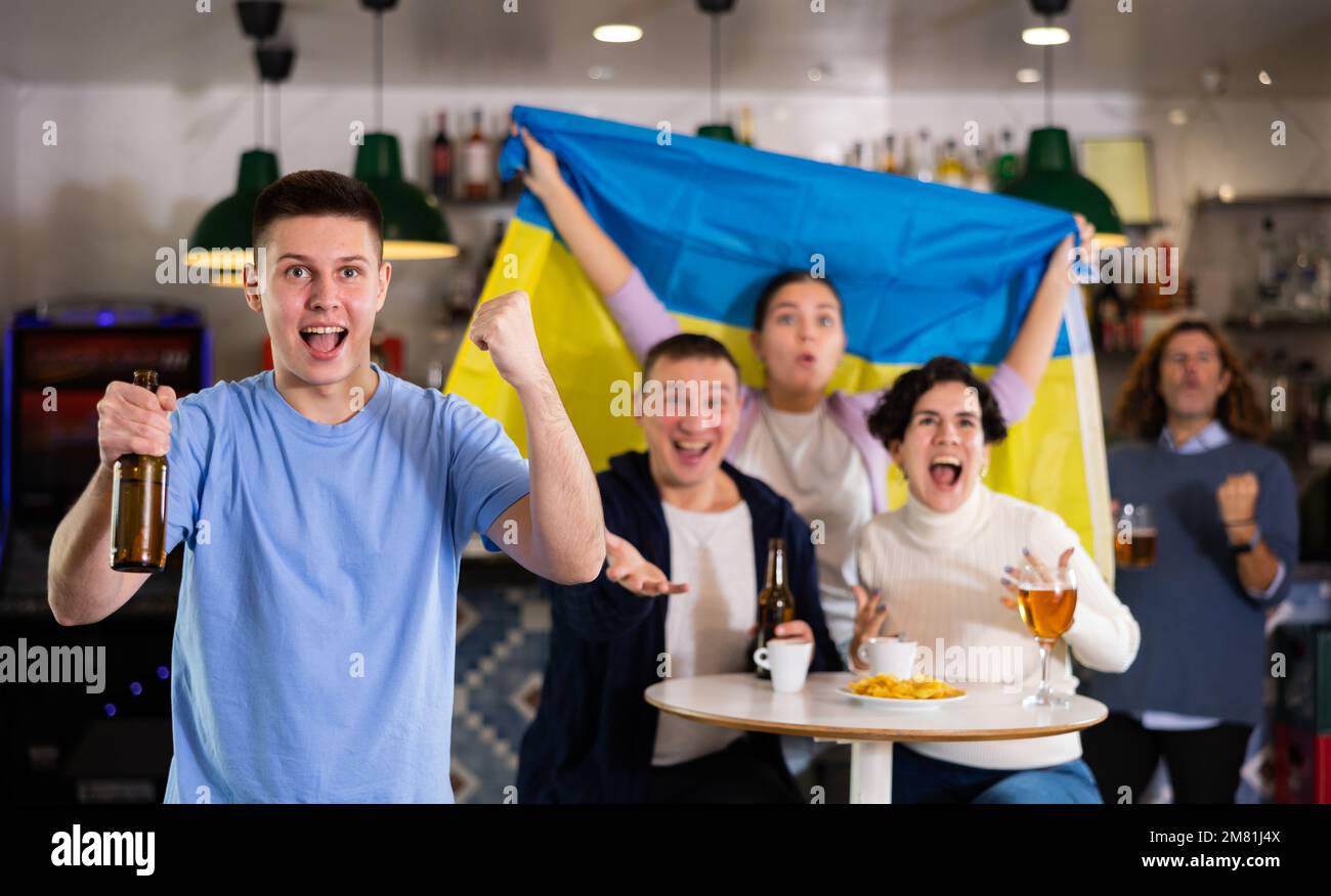 Happy friends of different ages drinking beer and celebrating the ...