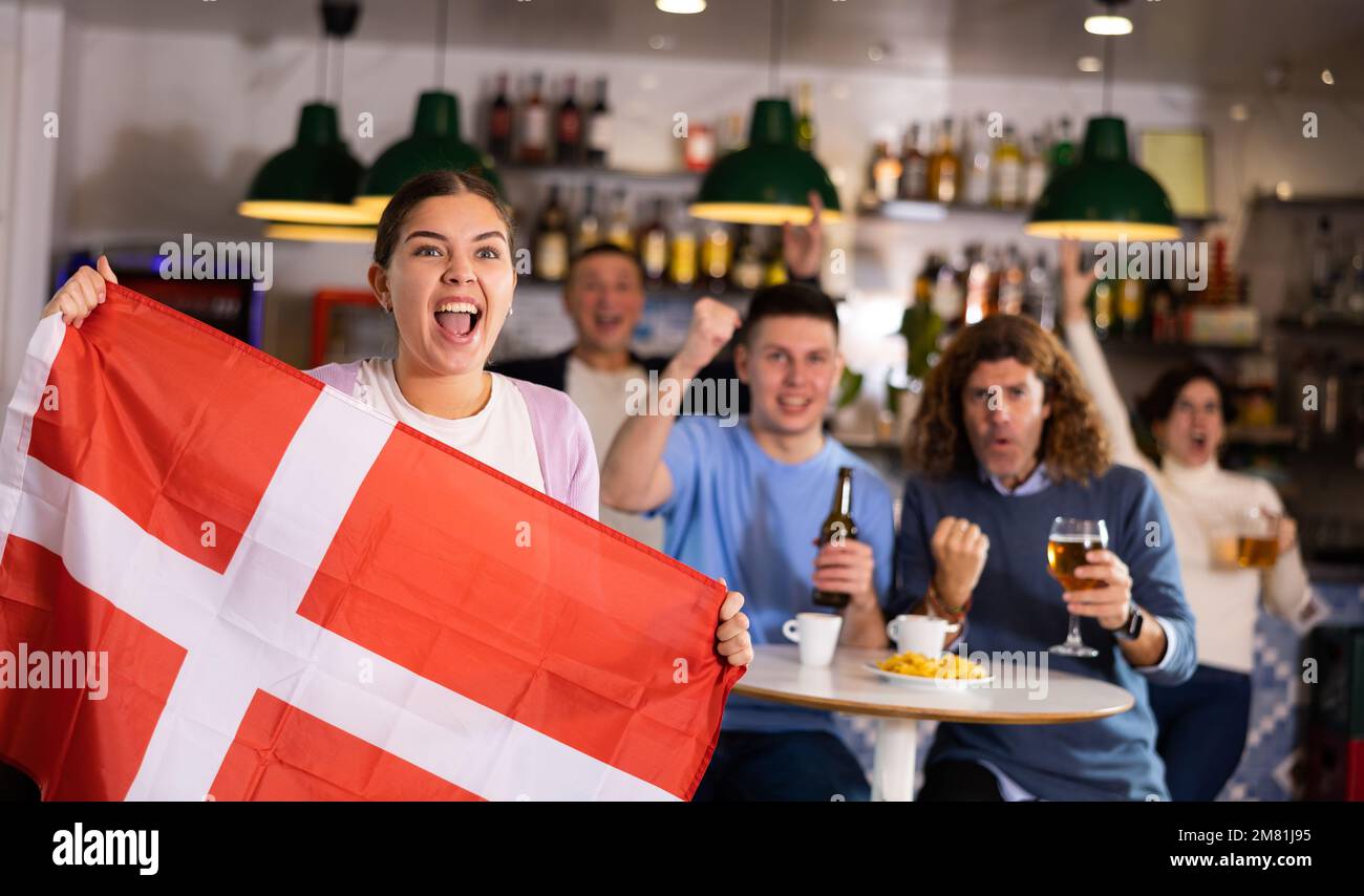 Screaming young adult sports fans rooting for favorite team and waving ...