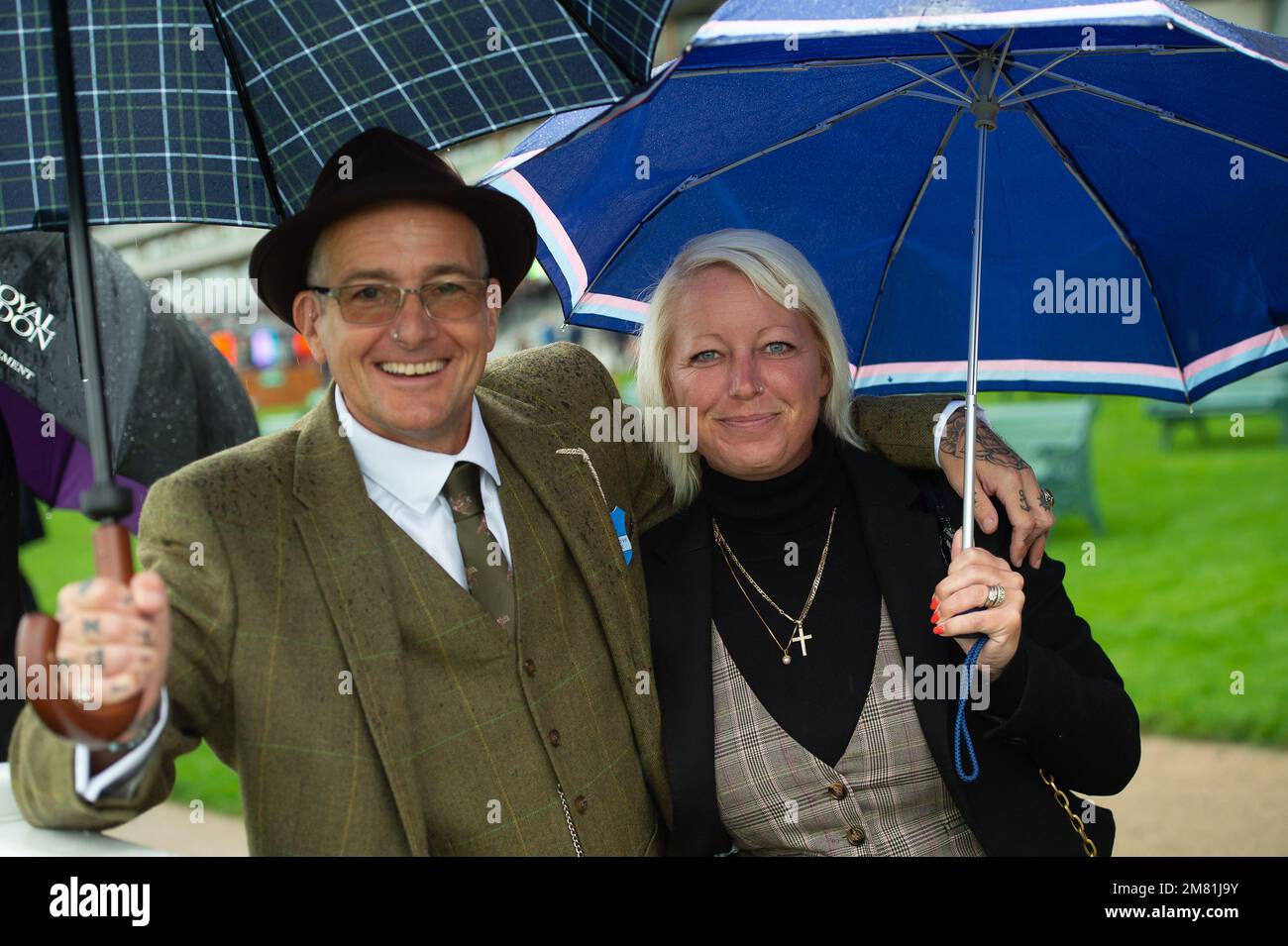 Ascot, Berkshire, UK. 2nd October, 2021. Racegoers with their umbrellas ...
