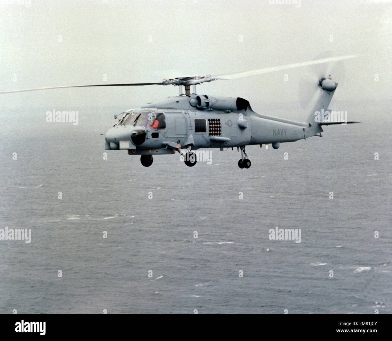 Left side view of an SH-60B Seahawk helicopter in-flight. The ...