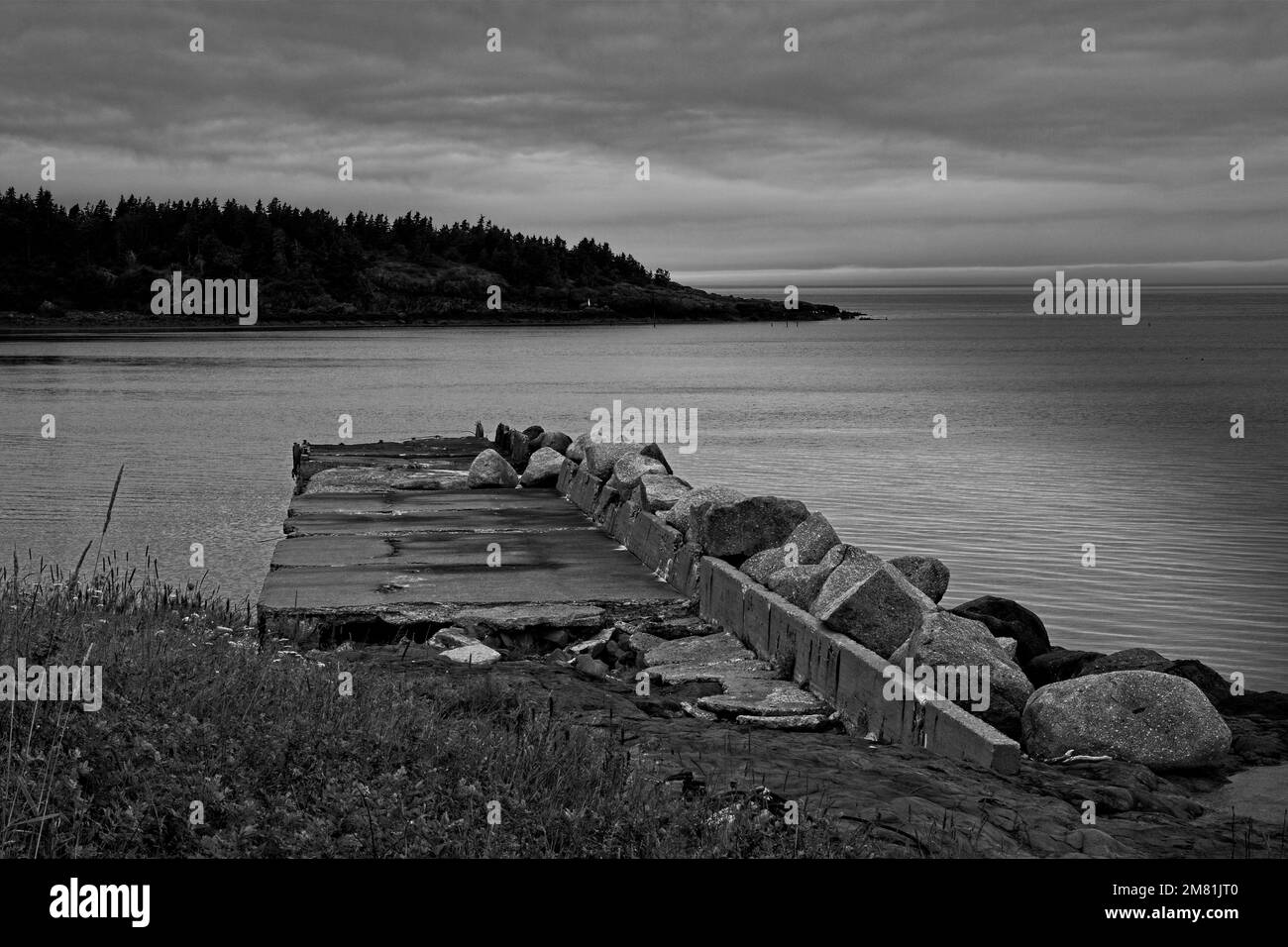 A black and white image of an old weathered fishing wharf. Sandy Cove ...