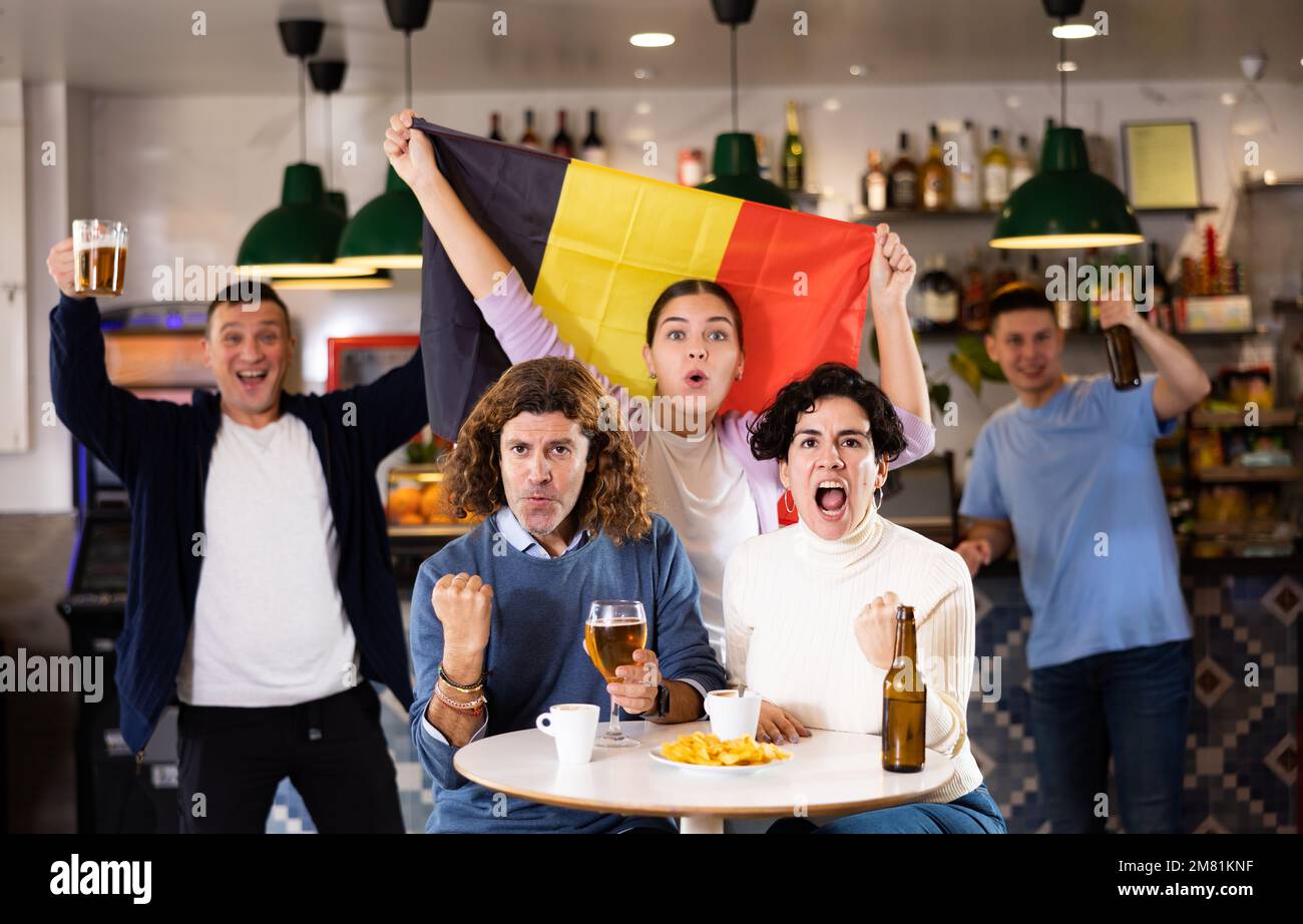 Happy fans celebrating the victory of Belgian team in bar Stock Photo ...