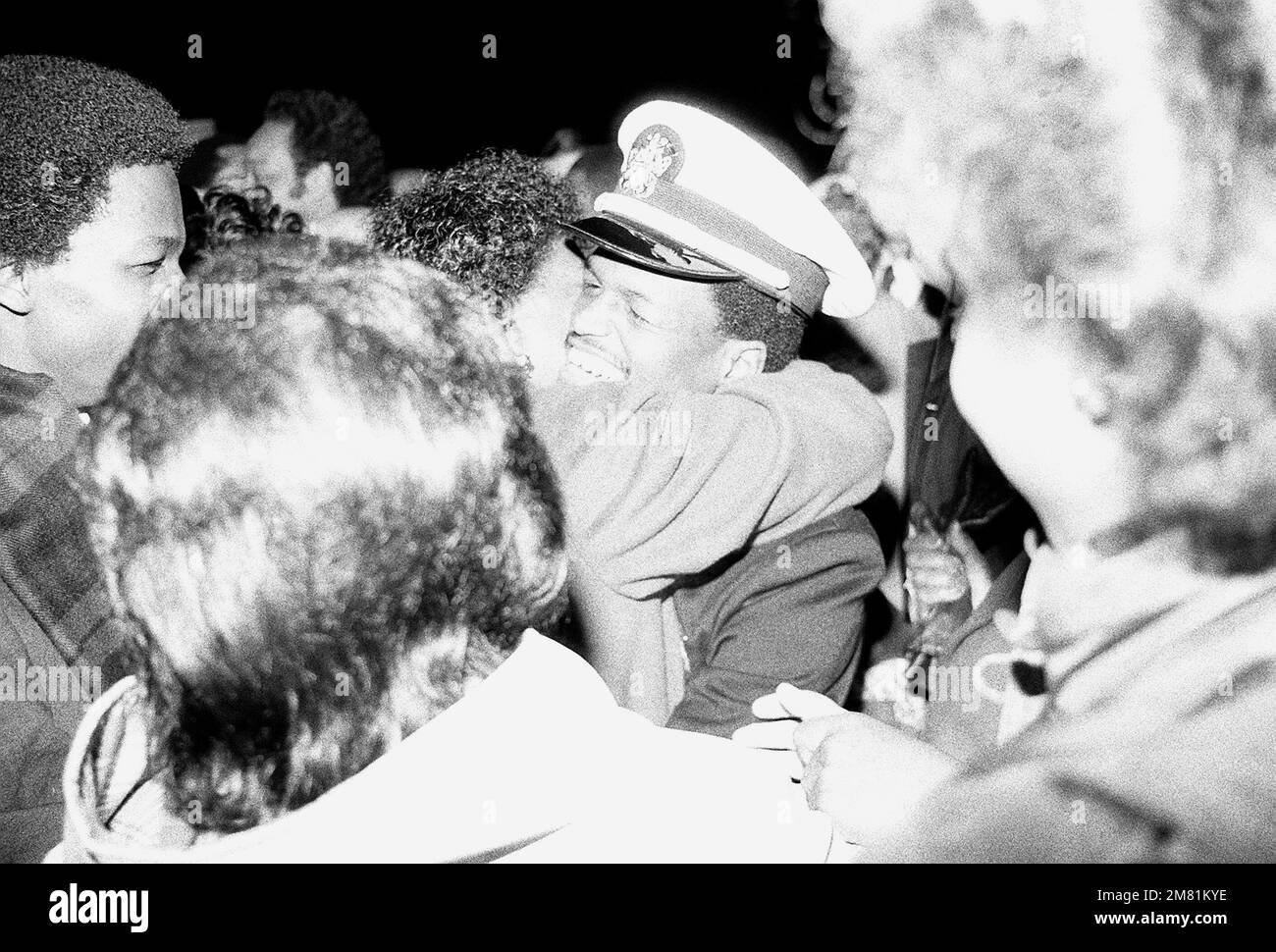 LT. Robert O. Goodman is greeted with a hug from his mother upon his ...