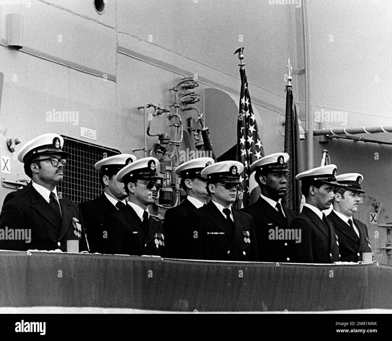 Crew members stand at attention aboard the guided missile frigate USS ...