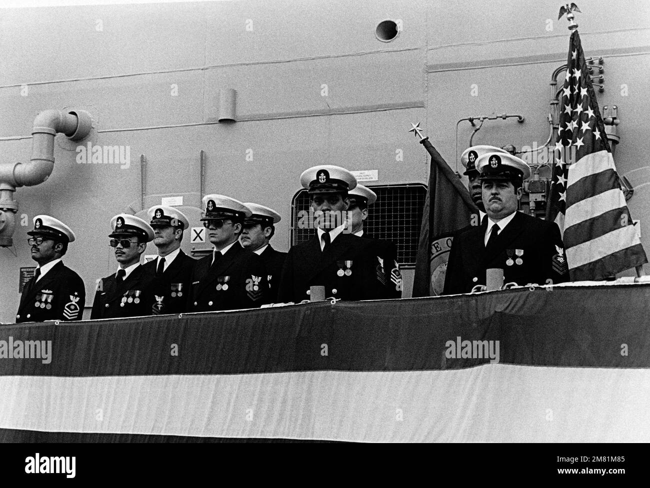 Crew members stand at attention aboard the guided missile frigate USS ...