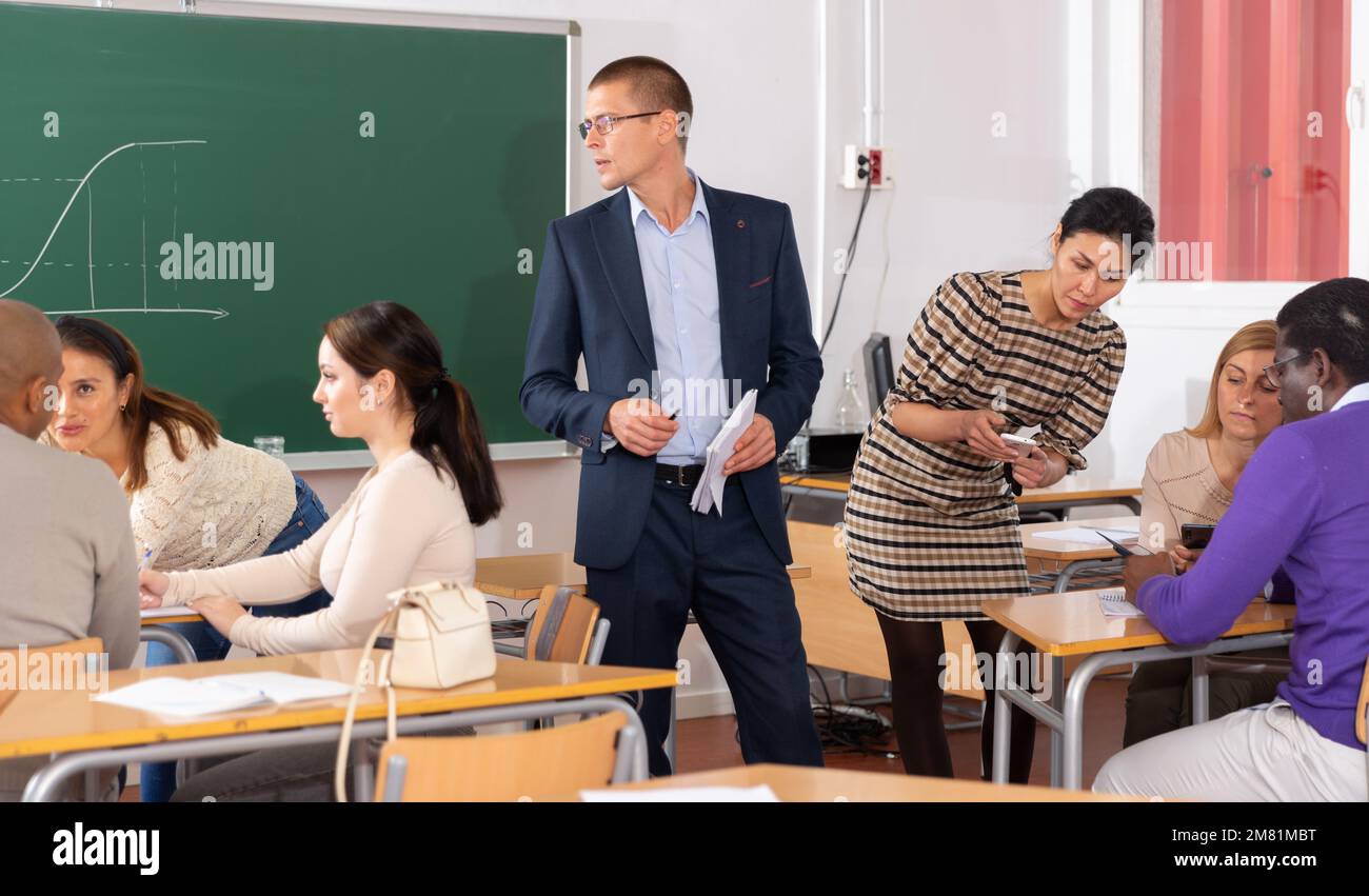 Teacher is giving lecture for students in class Stock Photo - Alamy