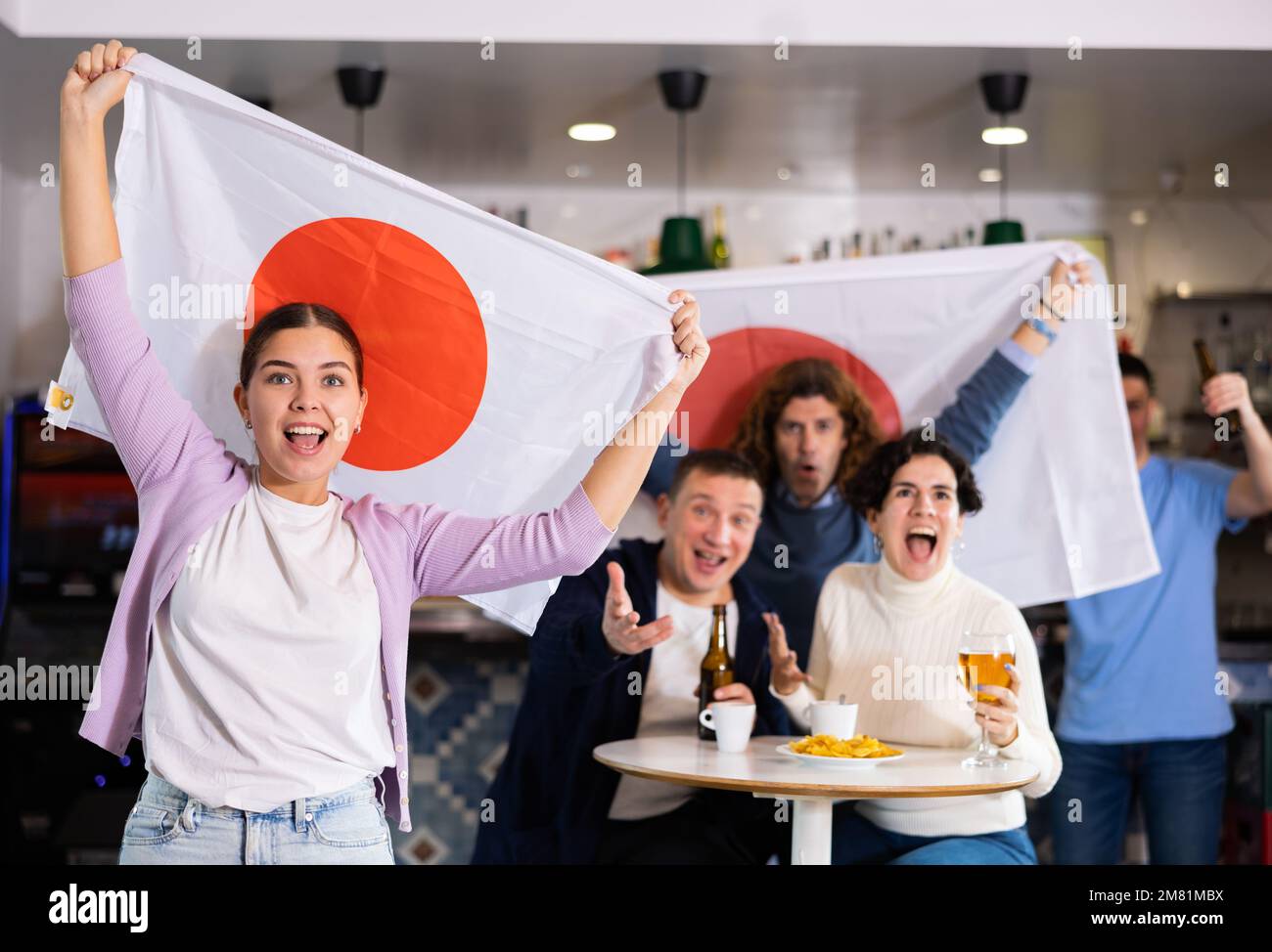 Group of happy fans celebrate victory of their favorite team with flag ...
