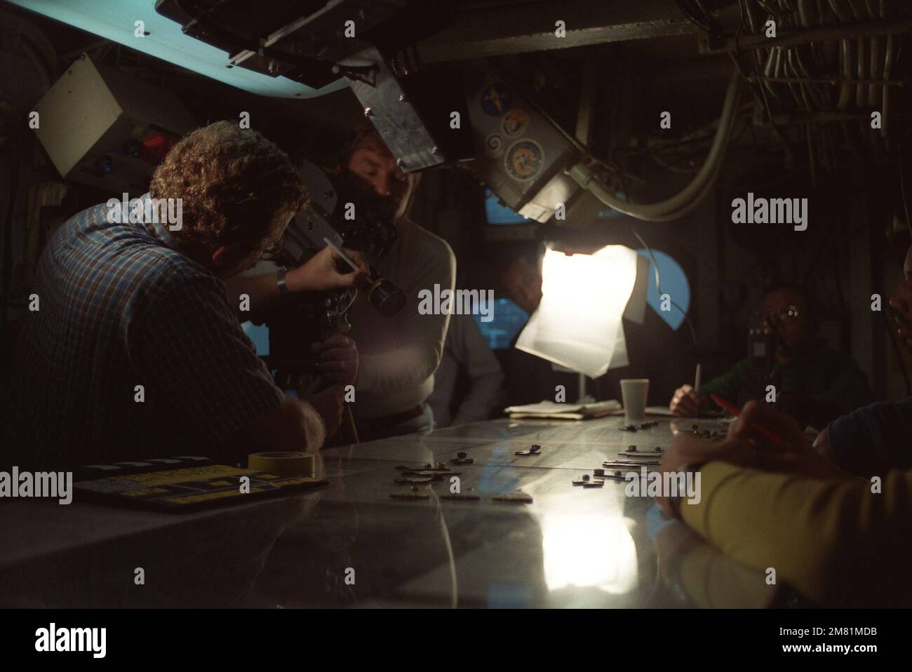 An audiovisual crew films personnel in the fight deck control operations area as they keep in ...