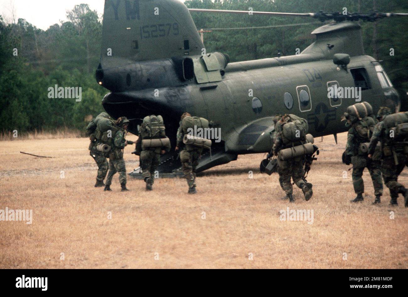 Marines board a CH-46 Sea Knight helicopter from the Marine Medium ...