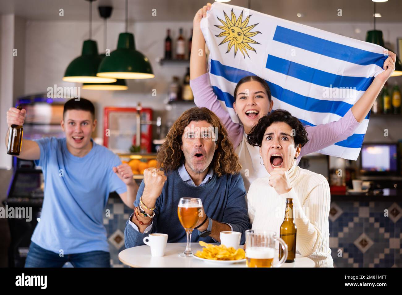 Screaming young adult sports fans rooting for favorite team and waving ...