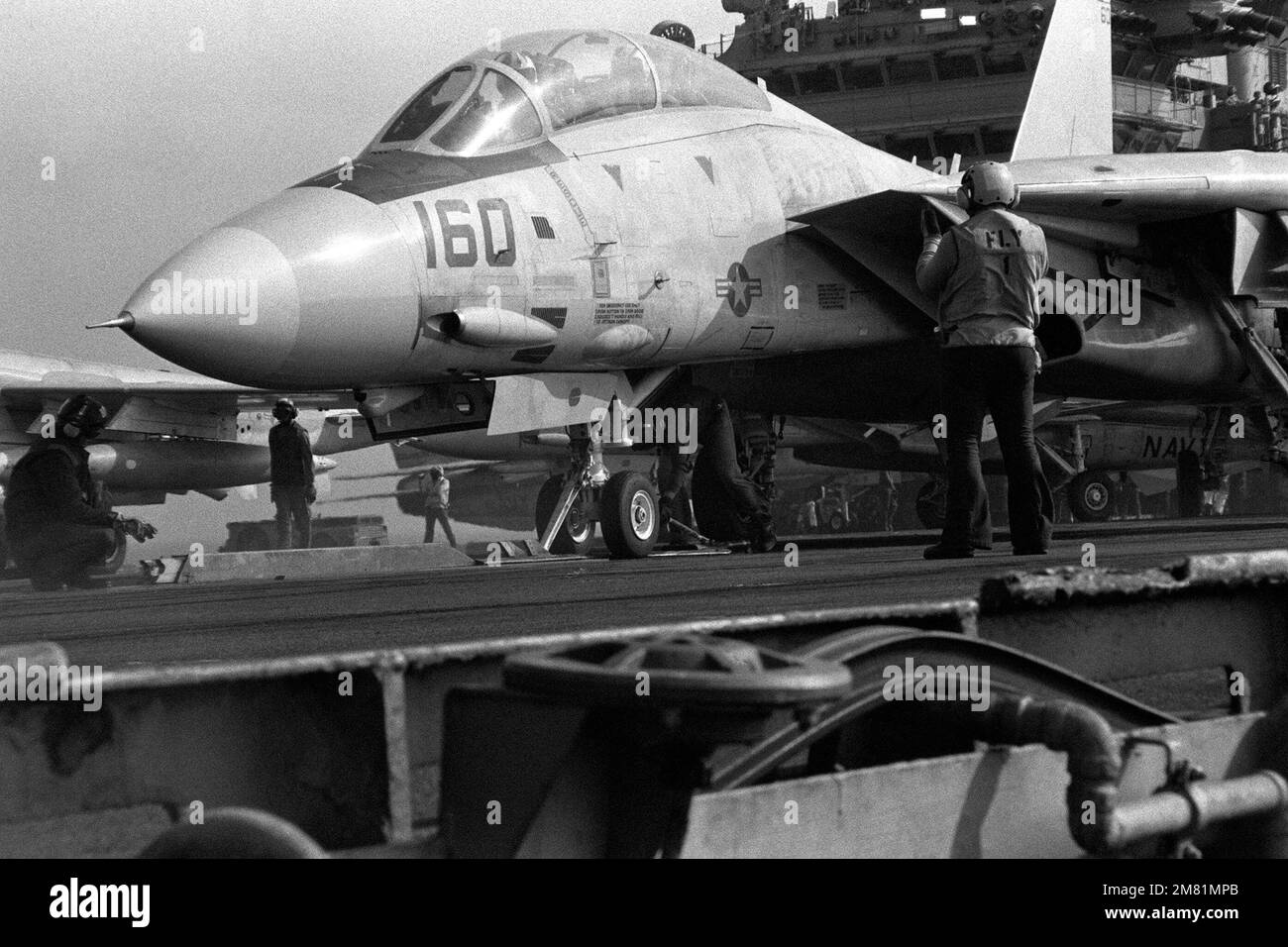 Left front view of an F-14 Tomcat aircraft preparing for launch aboard ...