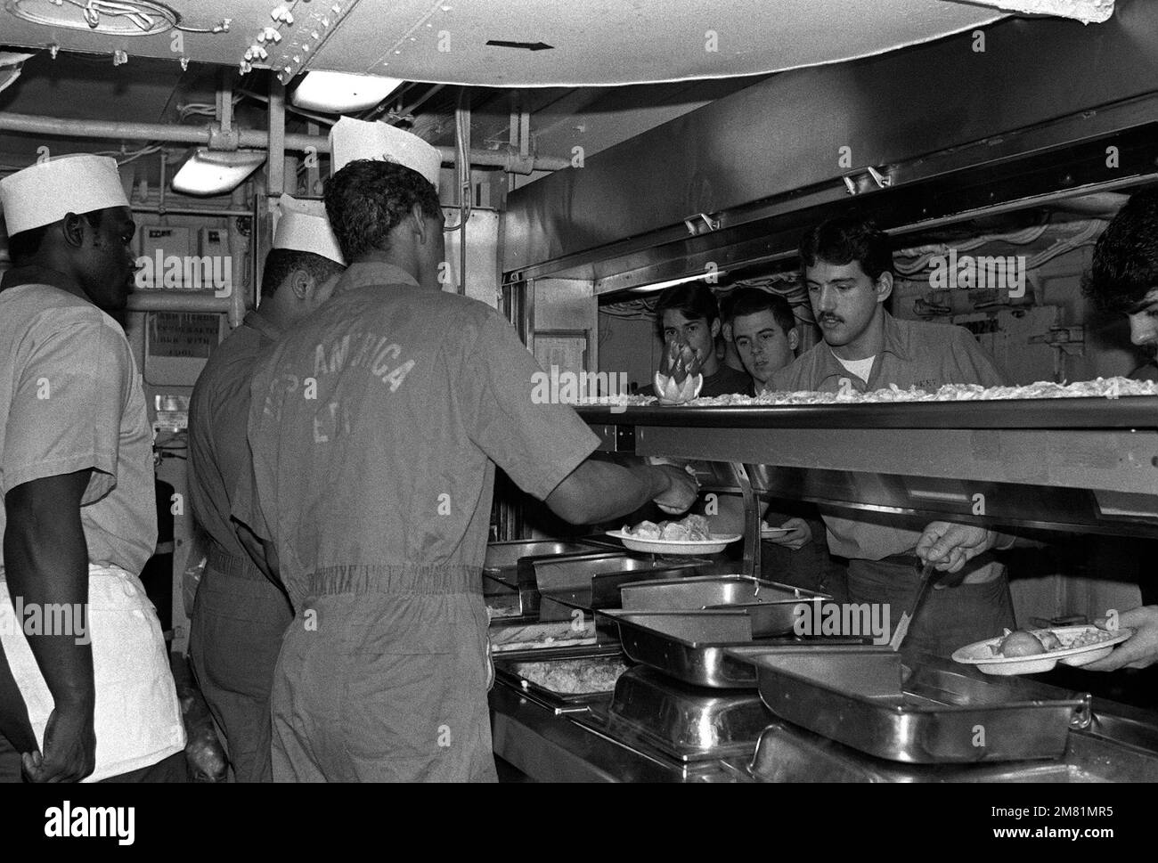 Mess management specialist serves lunch to the crew aboard the aircraft ...