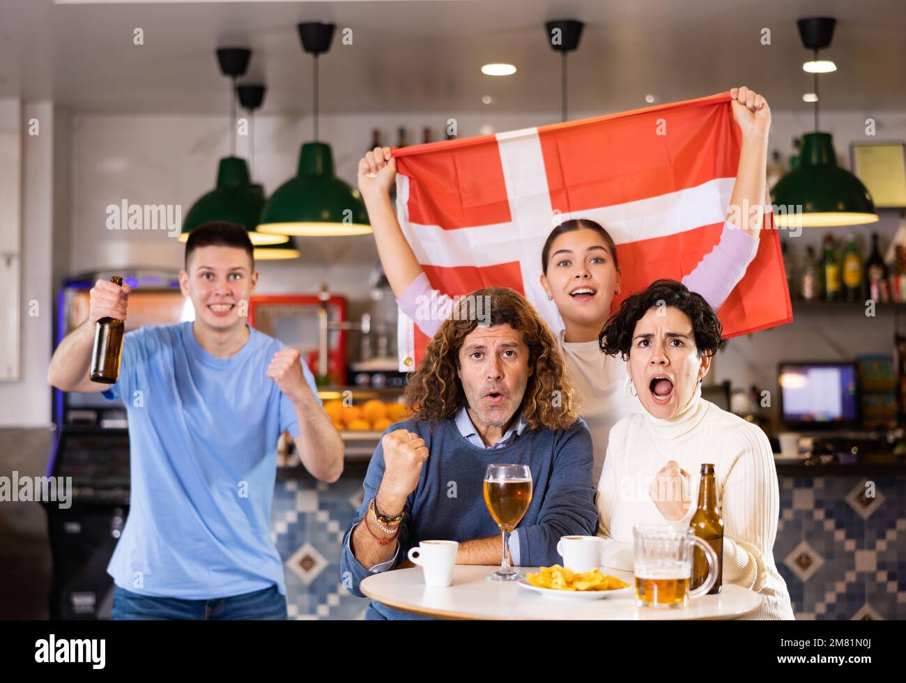 Screaming young adult sports fans rooting for favorite team and waving ...