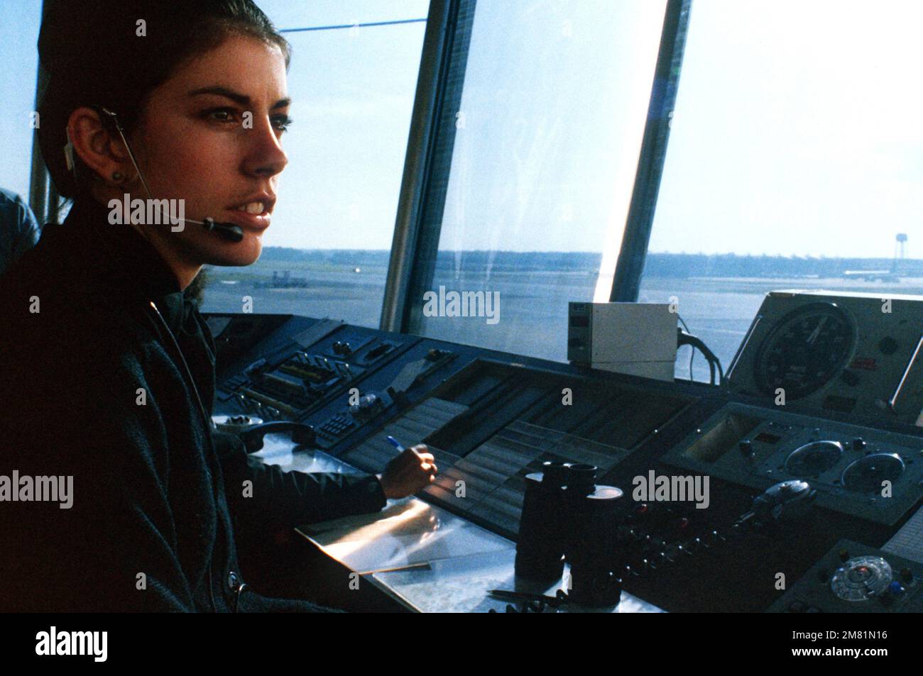 An air traffic controller studies the flight line from the control ...