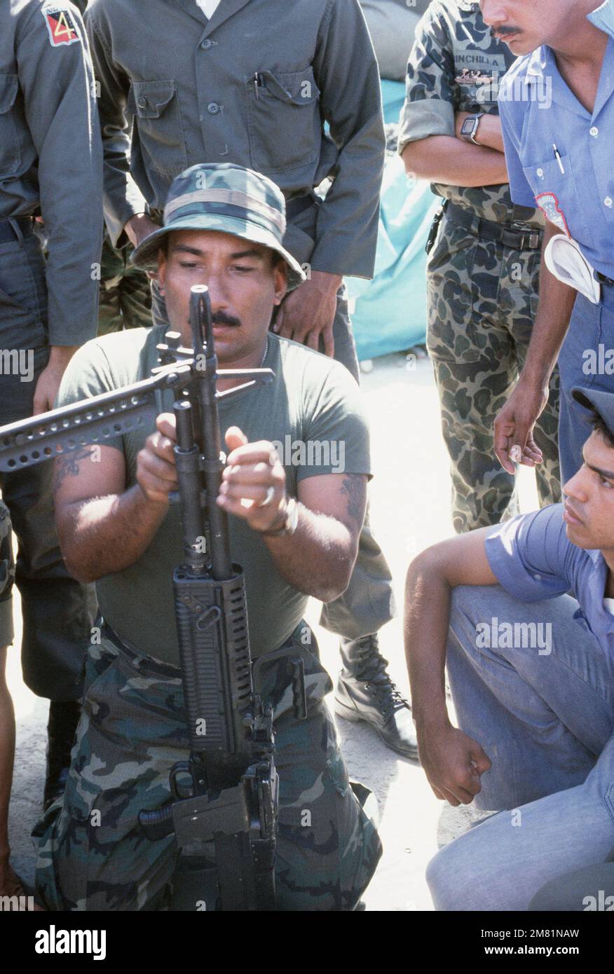 A US sailor instructs Honduran Marines in the operation and maintenance ...