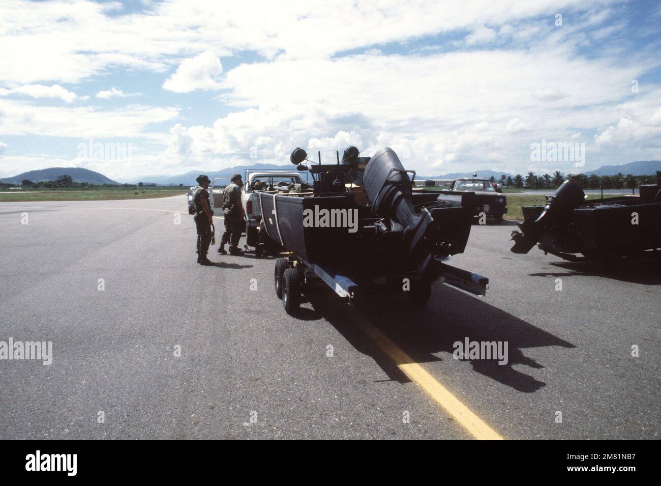 Members of a US Navy Combat Boat Unit prepare to tow their 18-foot ...