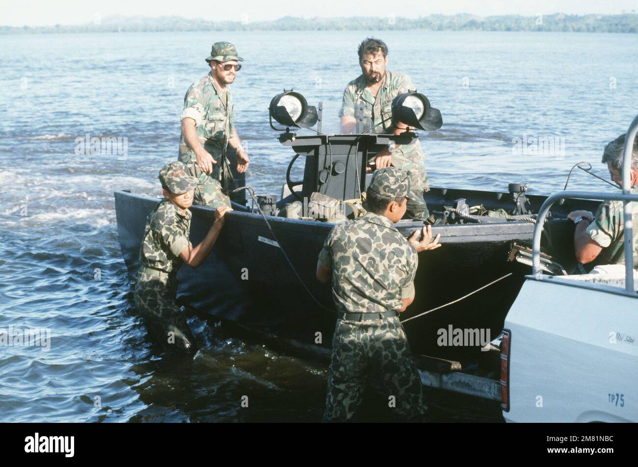 Members of a US Navy Combat Boat Unit from Panama haul their 18-foot ...