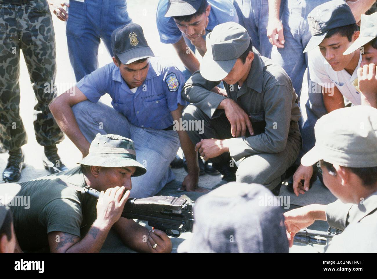 A US sailor instructs Honduran Marines in the operation and maintenance ...