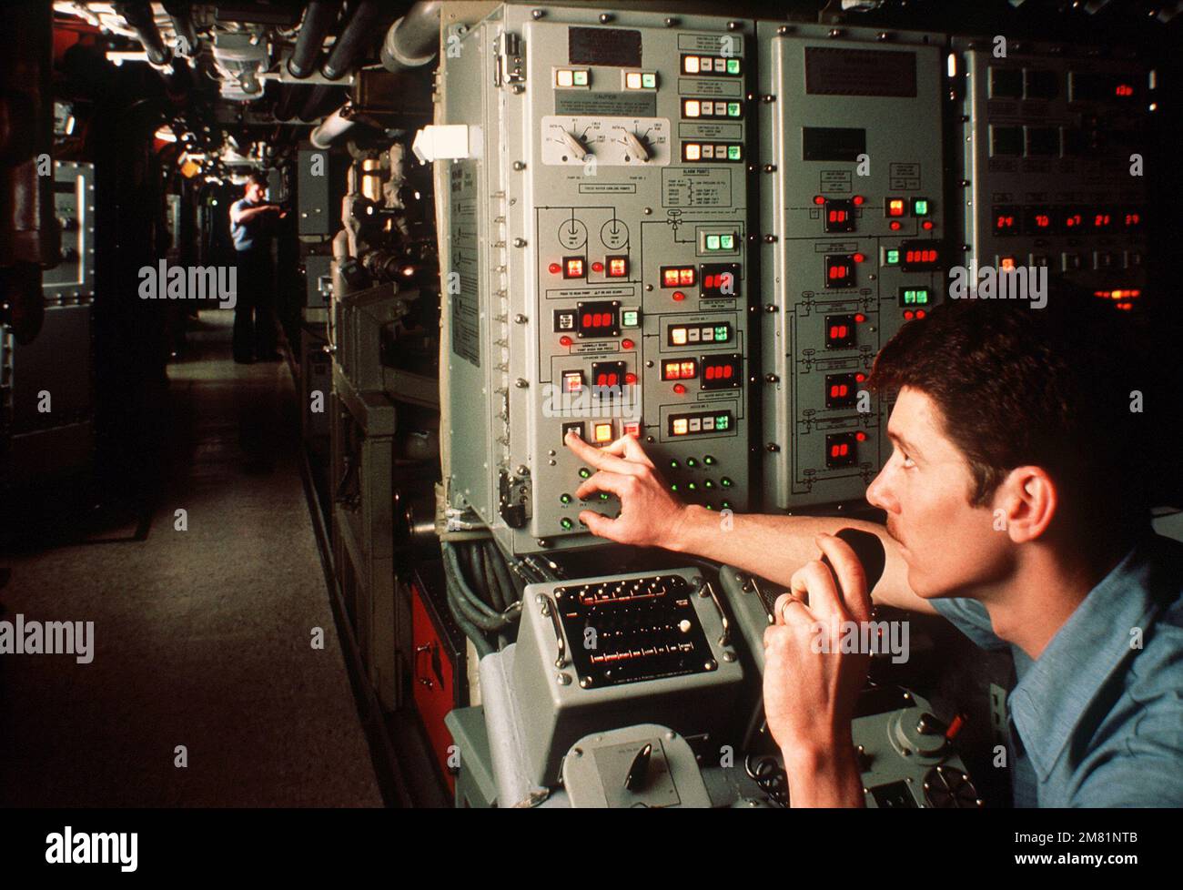 A crewman checks the internal systems of missiles in the missile ...
