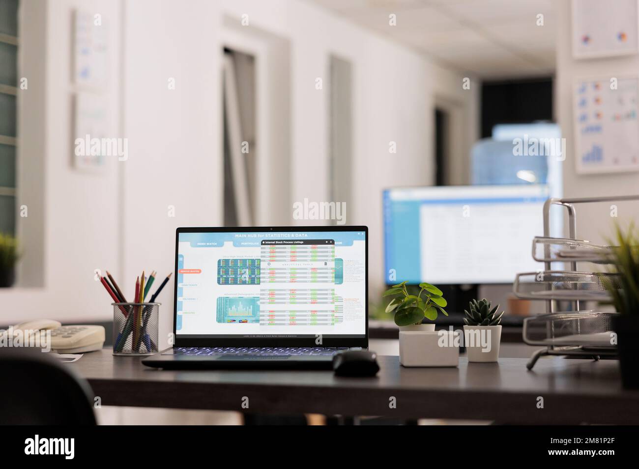 Modern office with no employees working late at night, laptop on ...