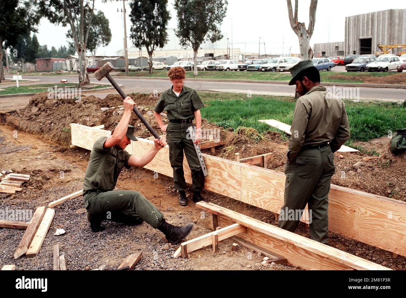 Members of a US Navy construction battalion prepare forms prior to ...