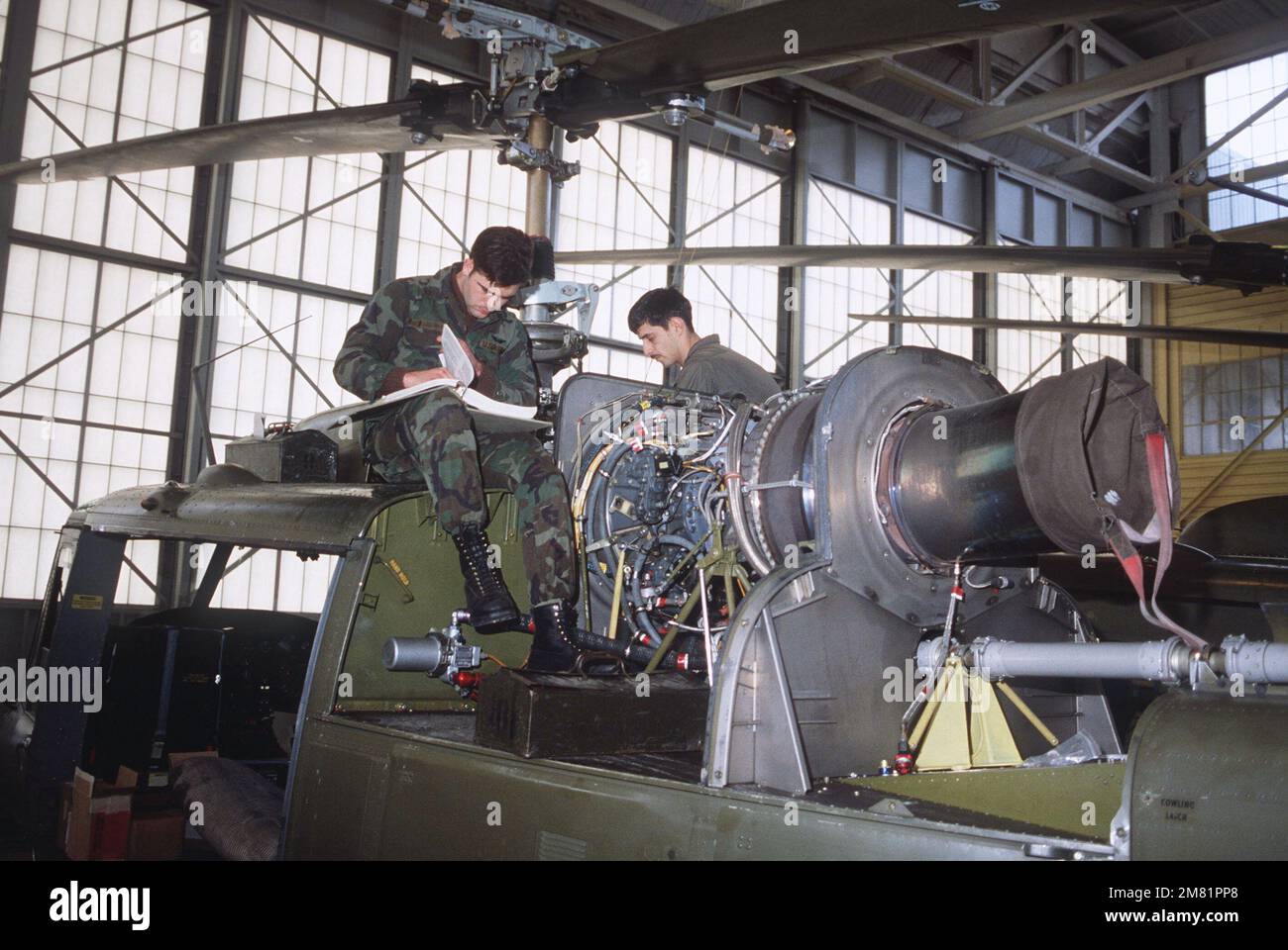 Private First Class Thomas M. Richardson refers to a technical manual ...