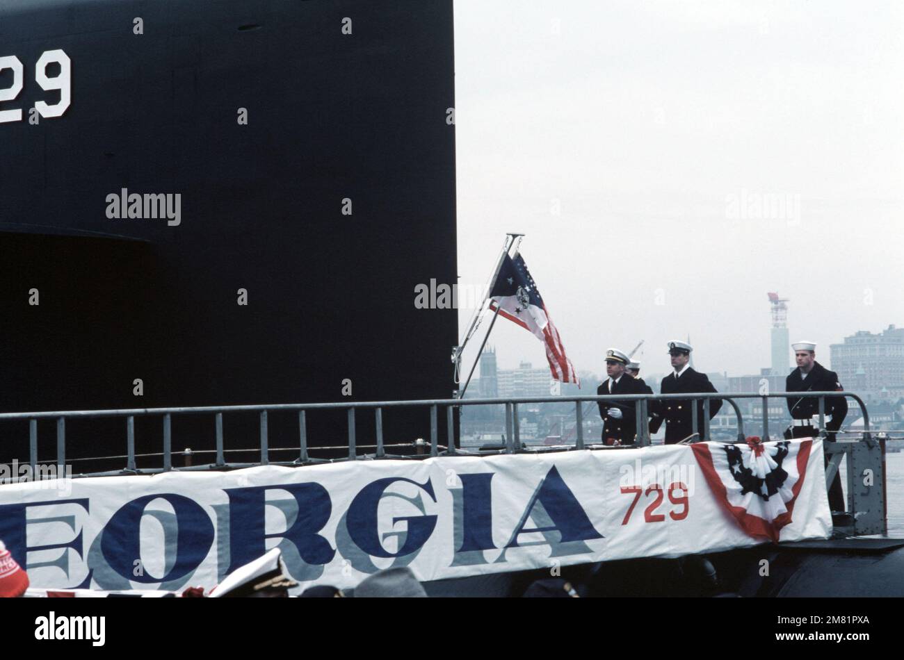 Lieutenant Commander William Stone, navigator stands with members of ...