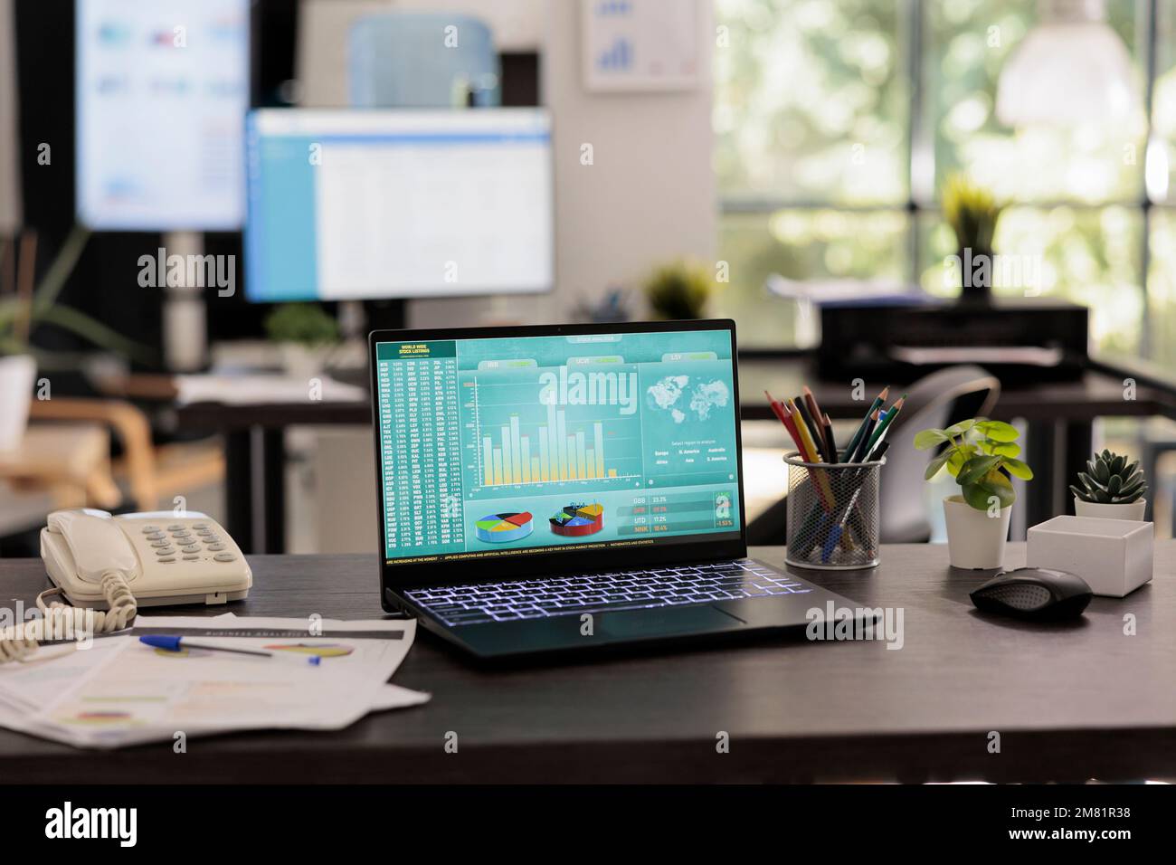 Computer running statistical management software on the office desk ...