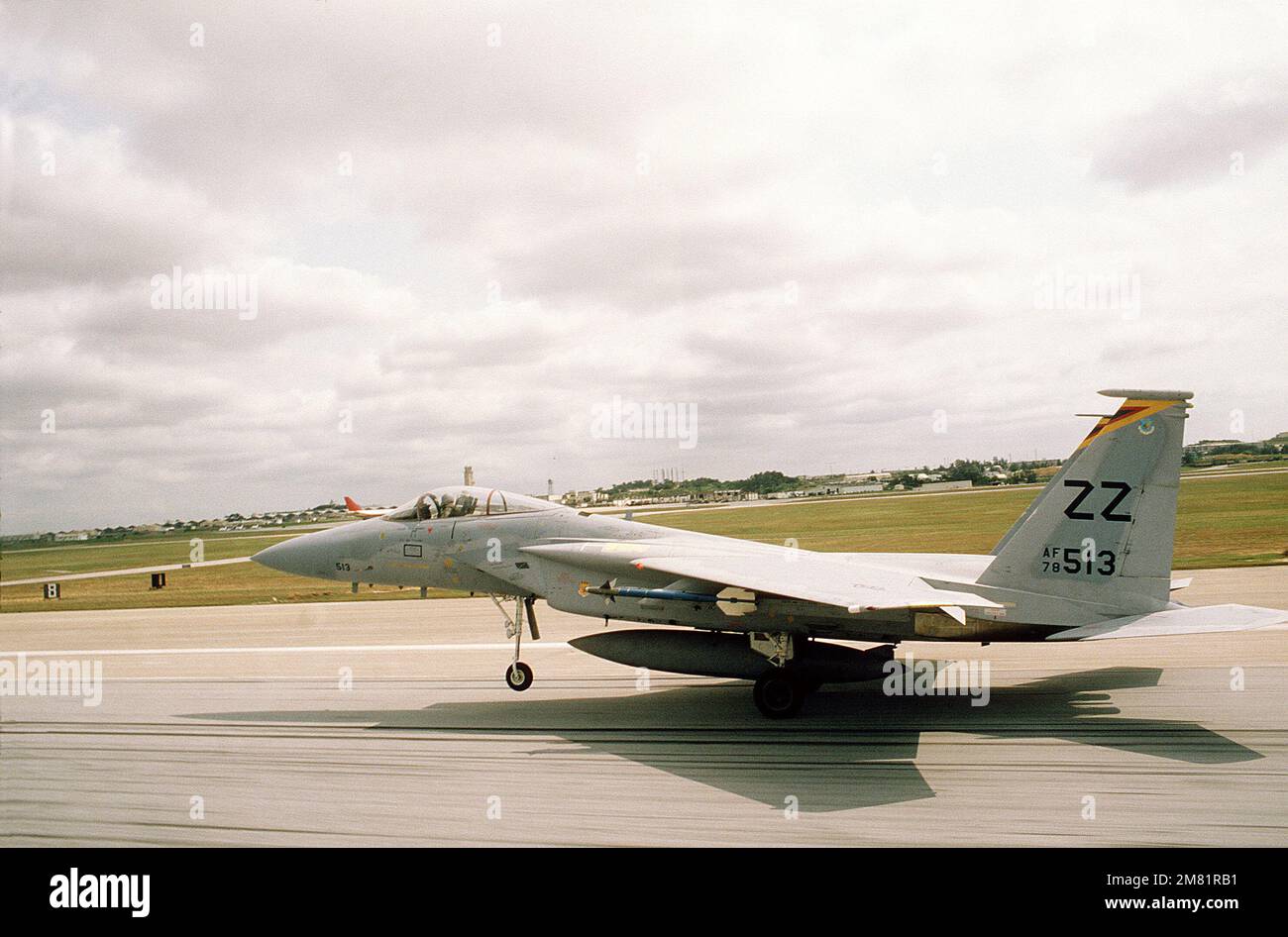 A left side view of an F-15 Eagle aircraft as it takes off. The ...