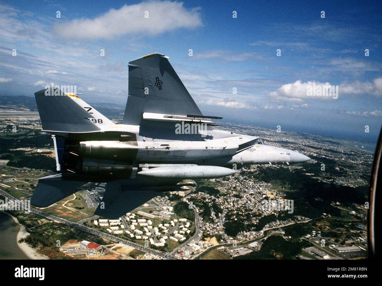 An air-to-air right side view of an F-15 Eagle aircraft as it banks to ...