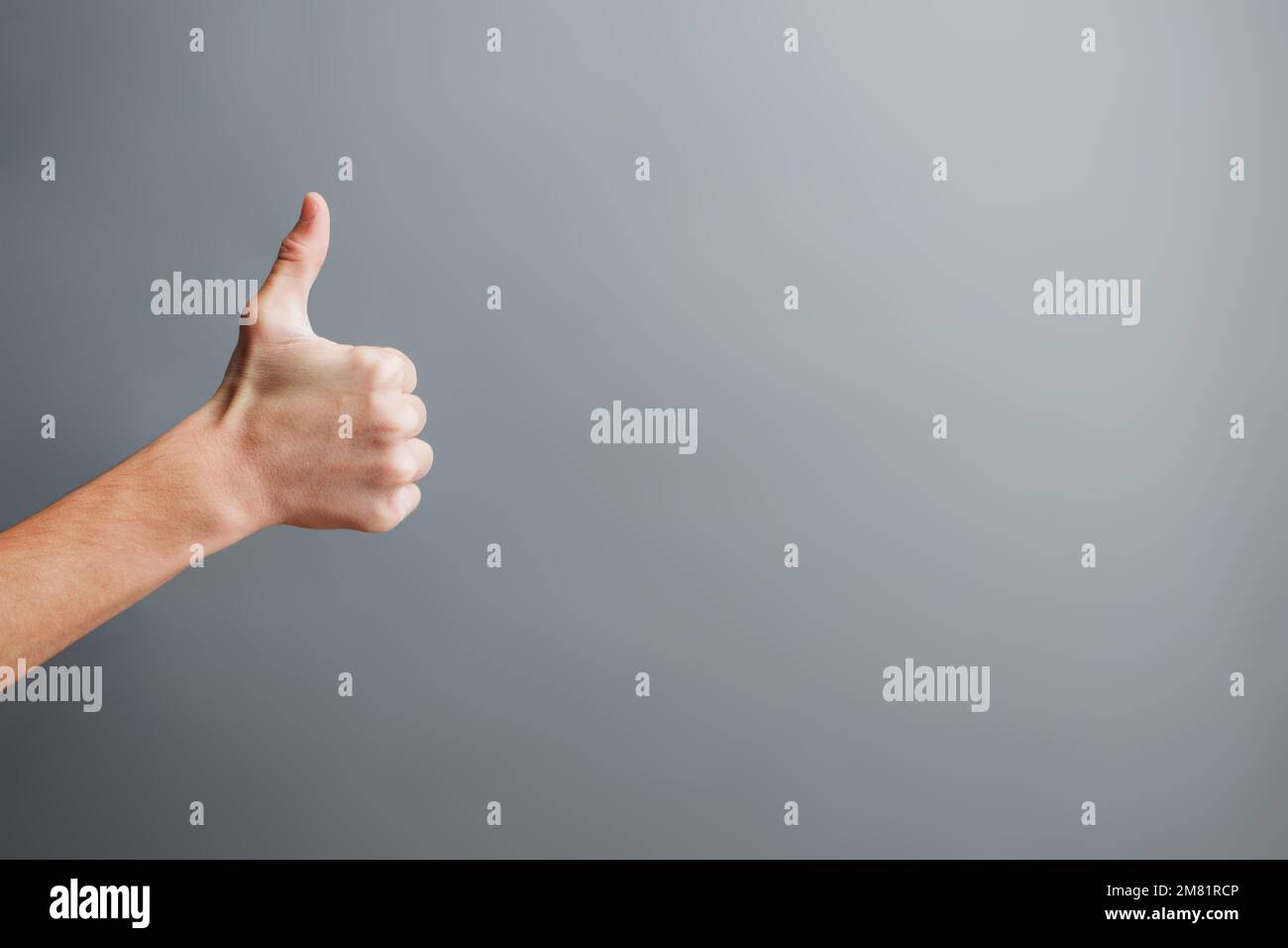Thumbs up dark background Stock Photo - Alamy
