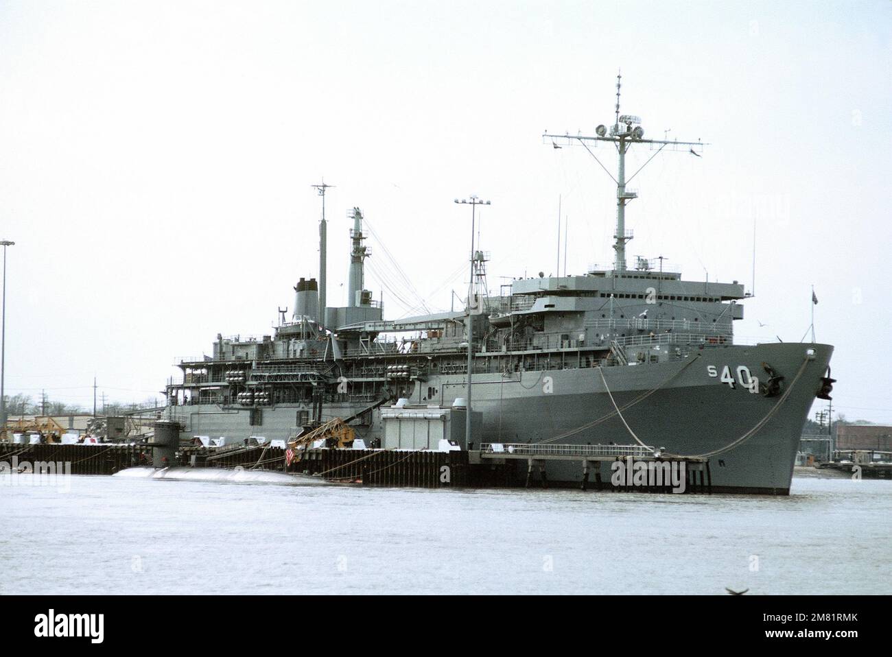 A starboard bow view of the Emery S. Land class submarine tender USS ...