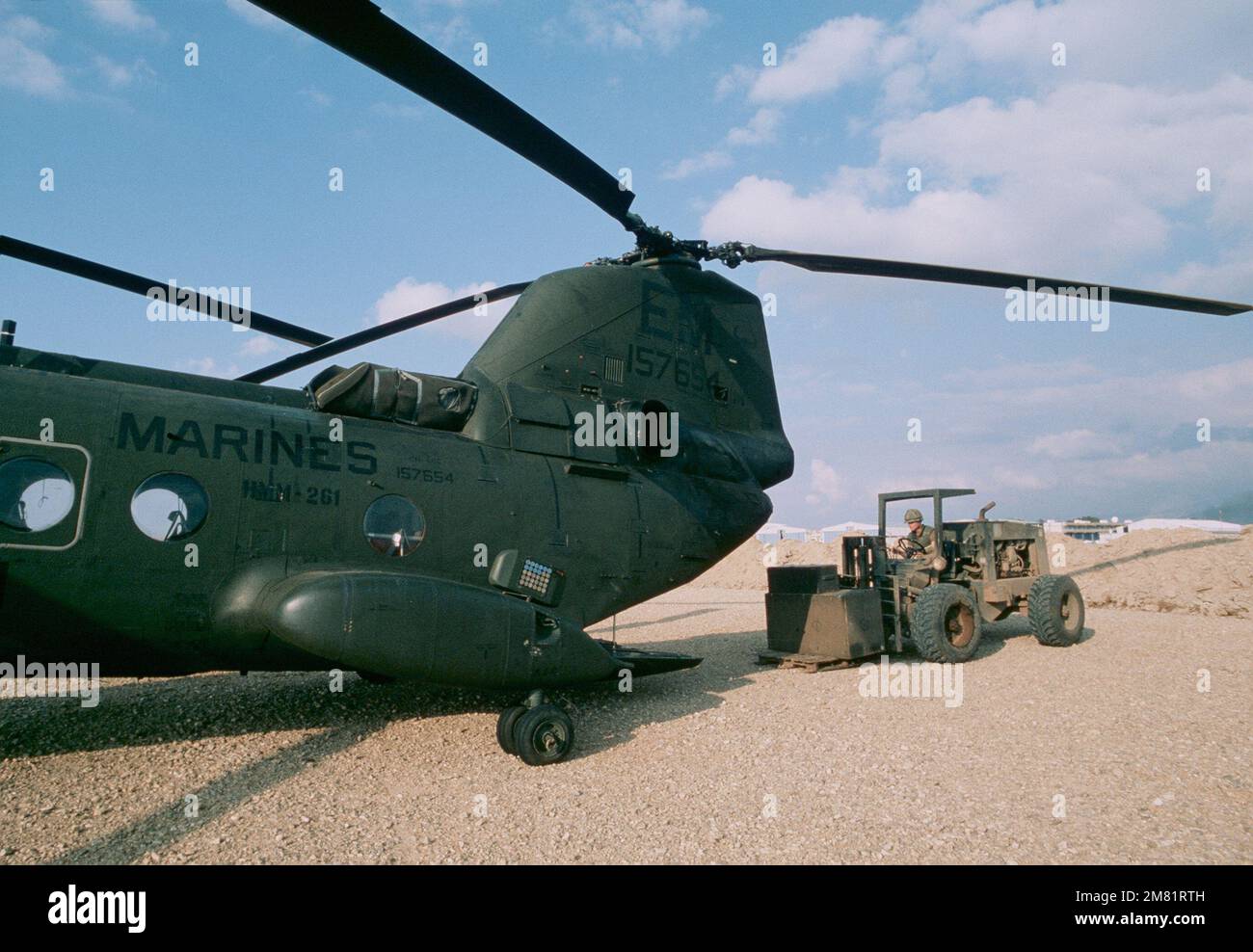 A Marine from the 22nd Marine Amphibious Unit uses a forklift to load ...