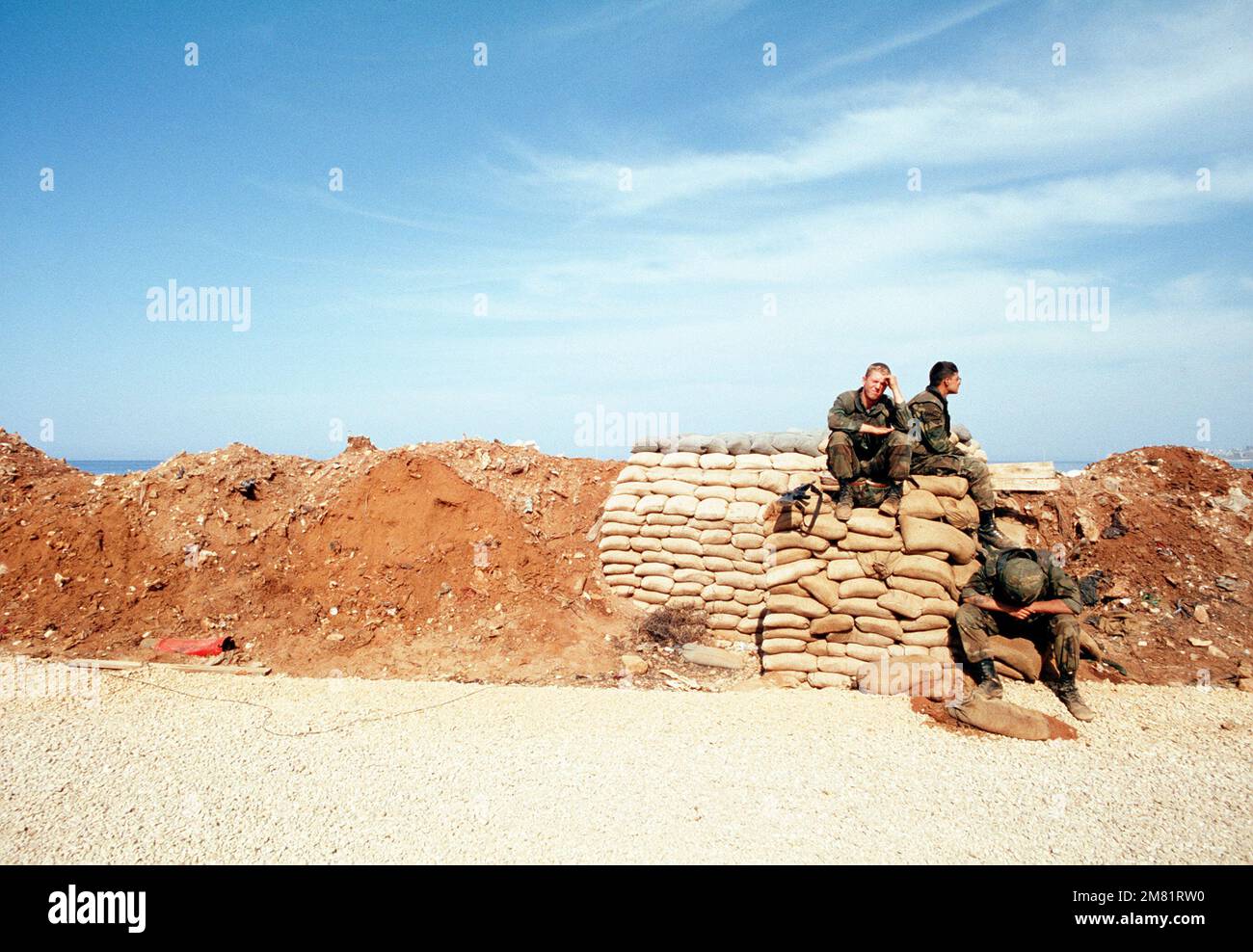 Marines of the 22nd Marine Amphibious Unit sit as they await orders to ...