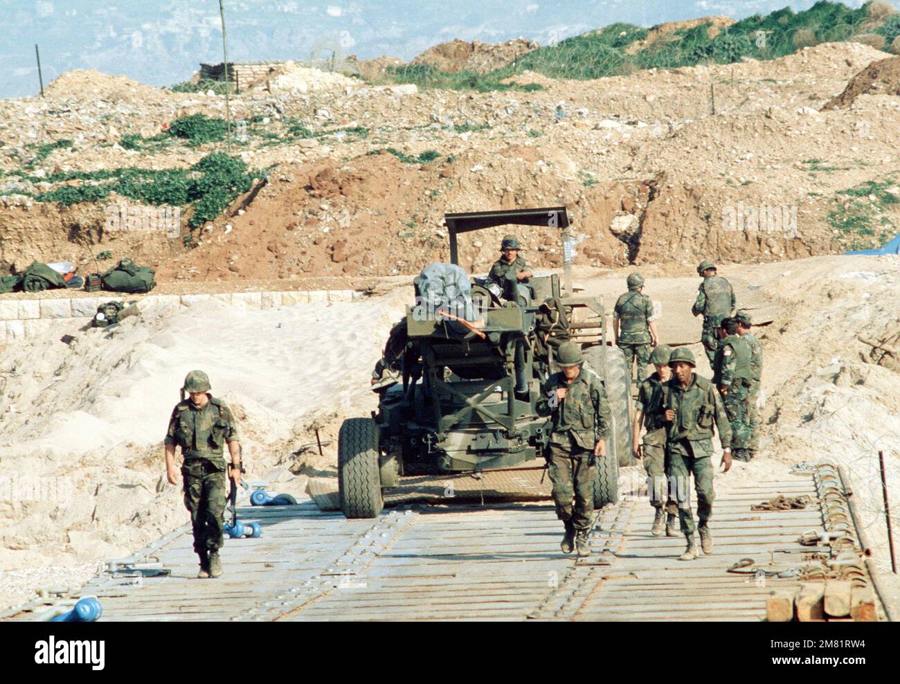 An M198 155 mm howitzer is loaded aboard a tank landing ship as Marines ...