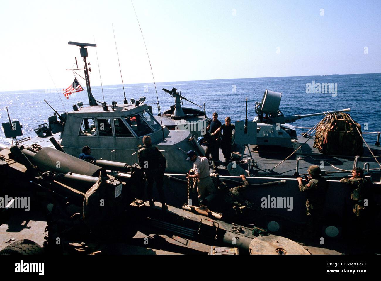 A patrol boat (PB Mark III) alongside a utility landing craft, as ...