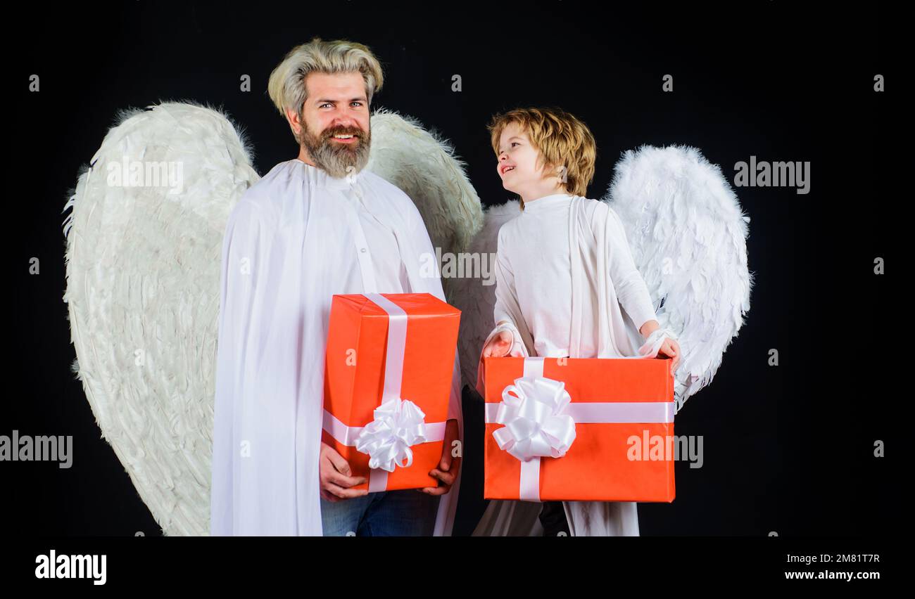 Valentines angels with gift box. Happy father and son in angel costume ...