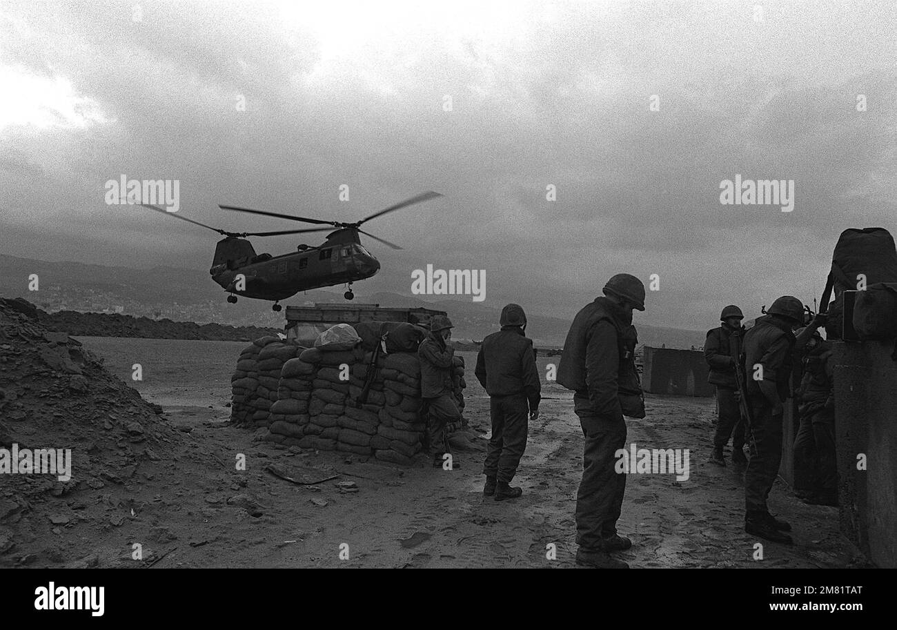 A CH-46 Sea Knight helicopter lands to pick up Seabees who are ...