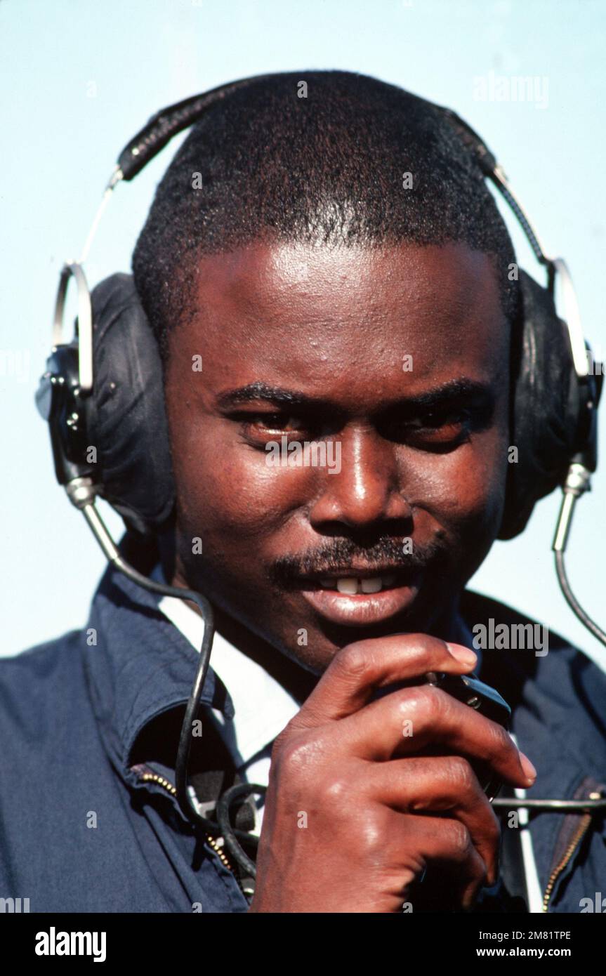 A phone talker operates a sound-powered phone aboard the amphibious ...