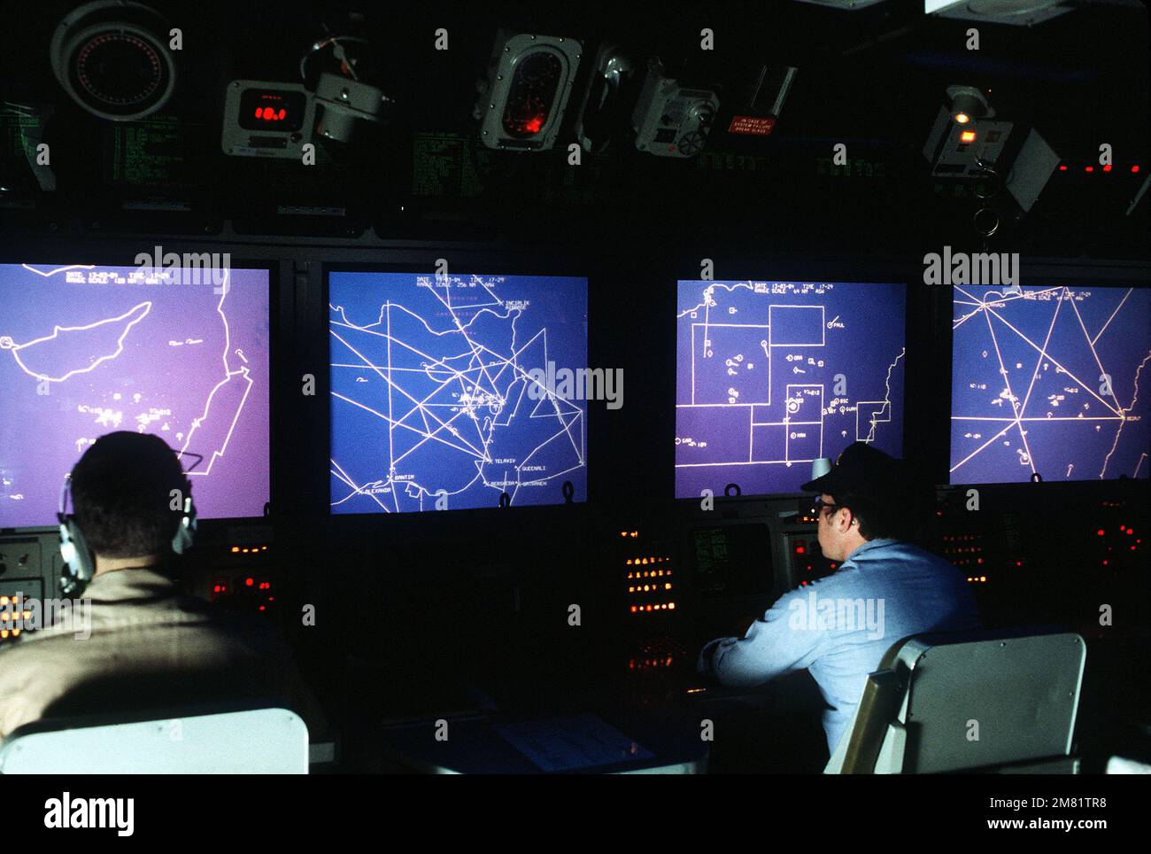 Technicians monitor displays in the combat information center aboard ...