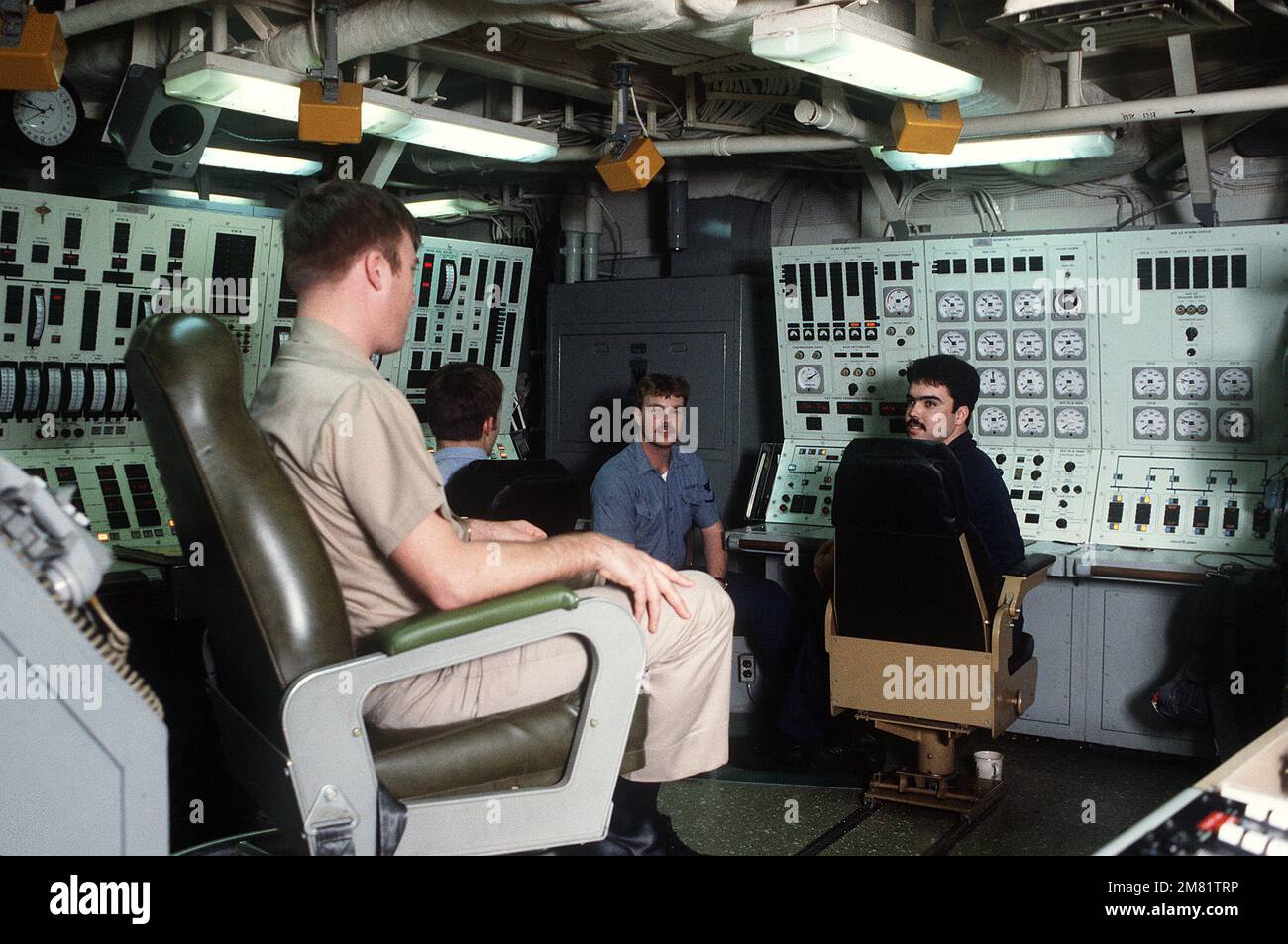 An officer discusses operations with technicians in the engineering ...