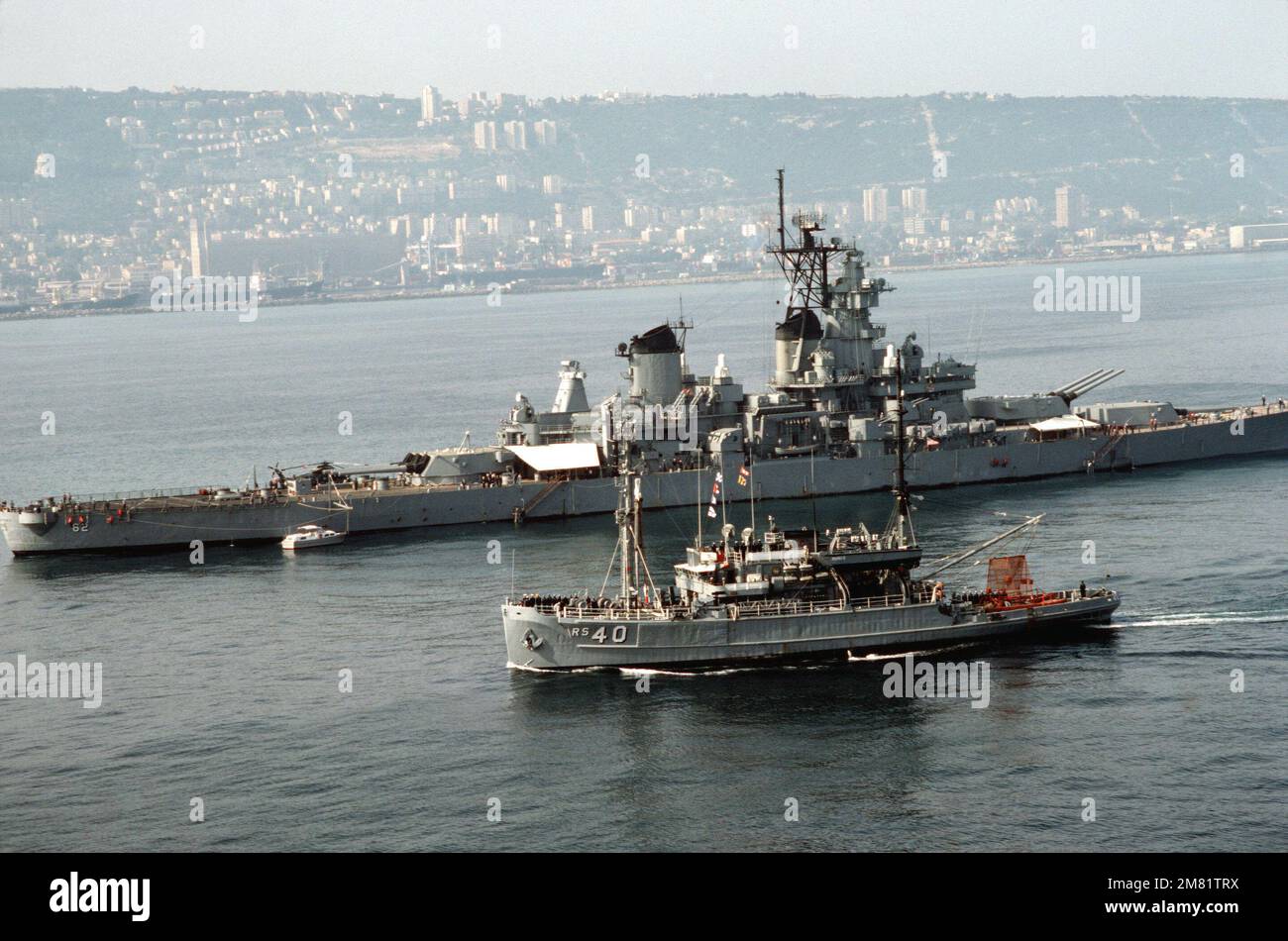 The salvage ship USS HOIST (ARS 40) passes the starboard side of the ...