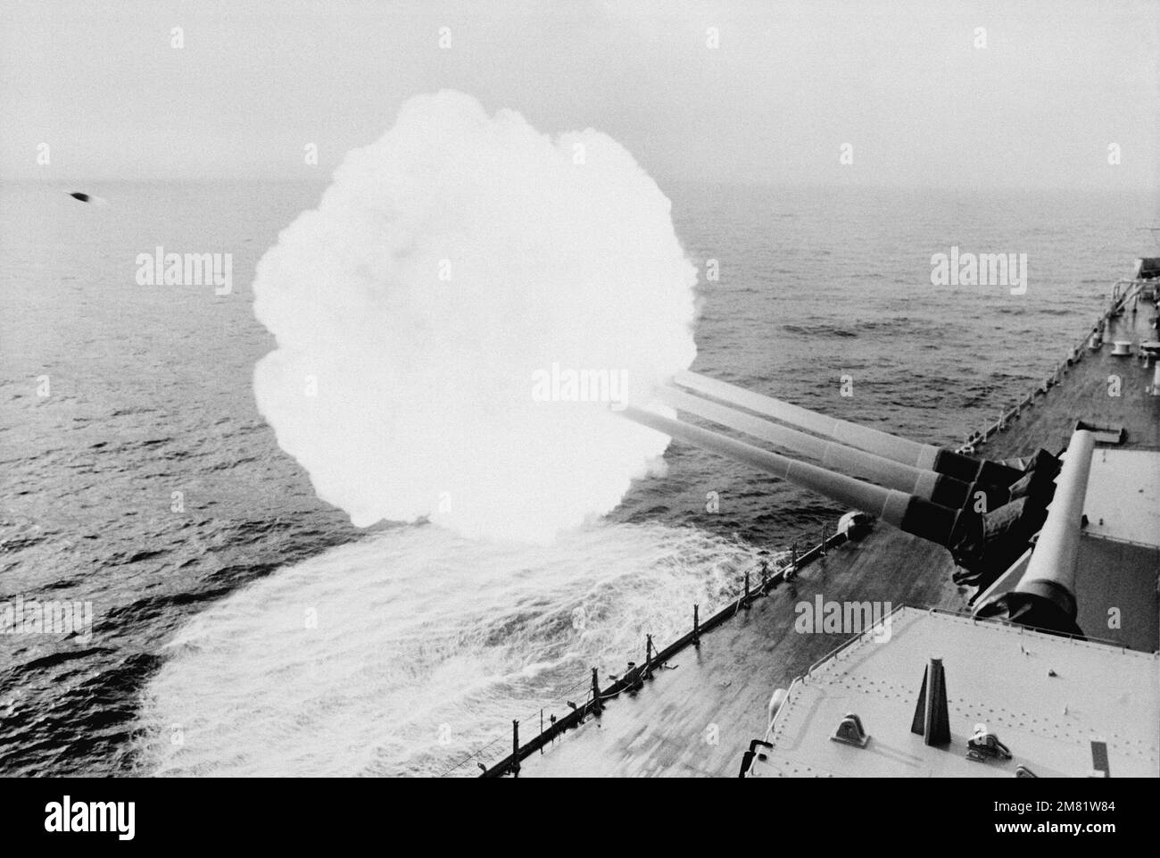 A 2,700-pound projectile is fired from the barrel of a forward 16-inch ...