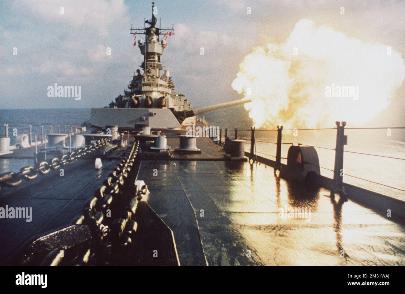 A 2,700-pound projectile is fired from the barrel of a forward 16-inch ...