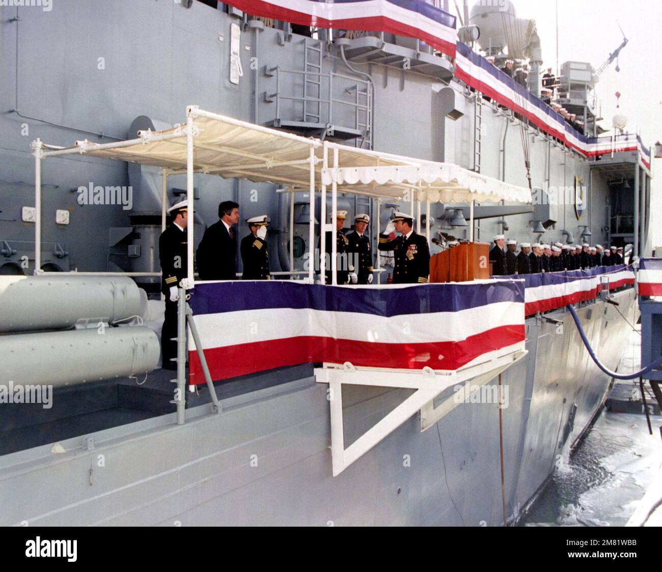 Officers and crew members participate in the commissioning of the ...
