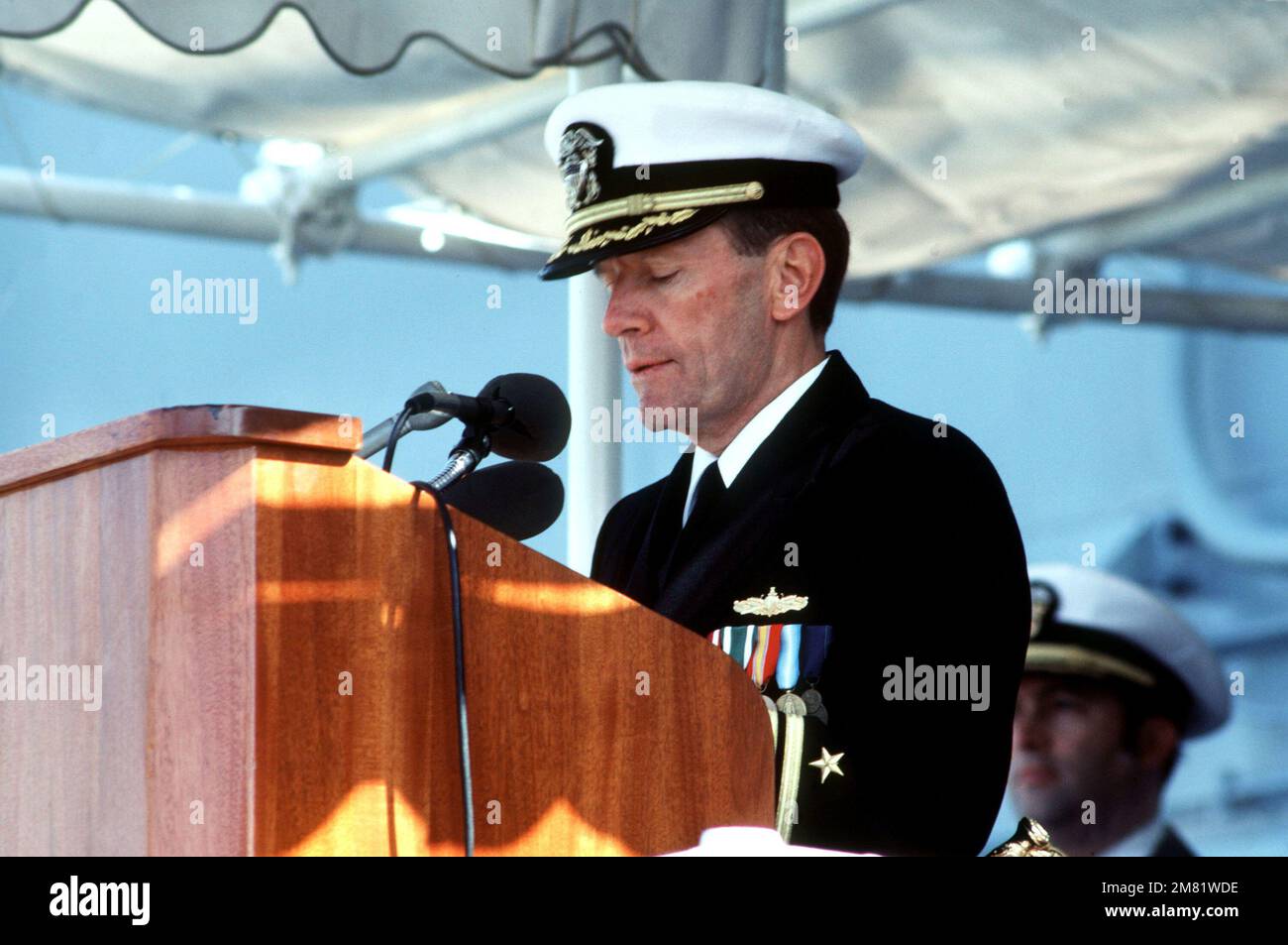 An officer addresses guests attending the commissioning ceremony for ...