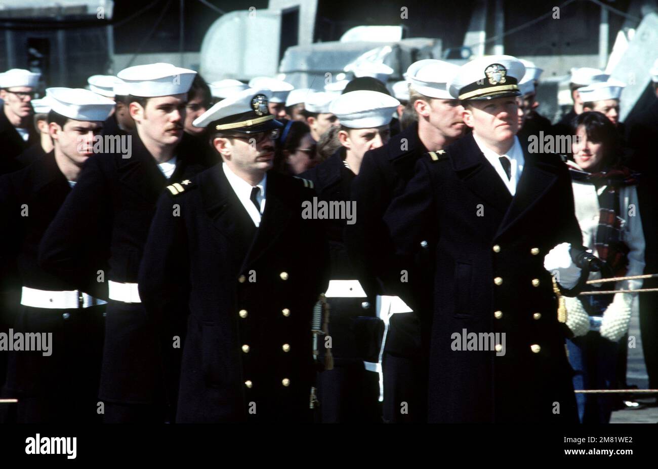 Crew members stand at attention during the commissioning ceremony for ...