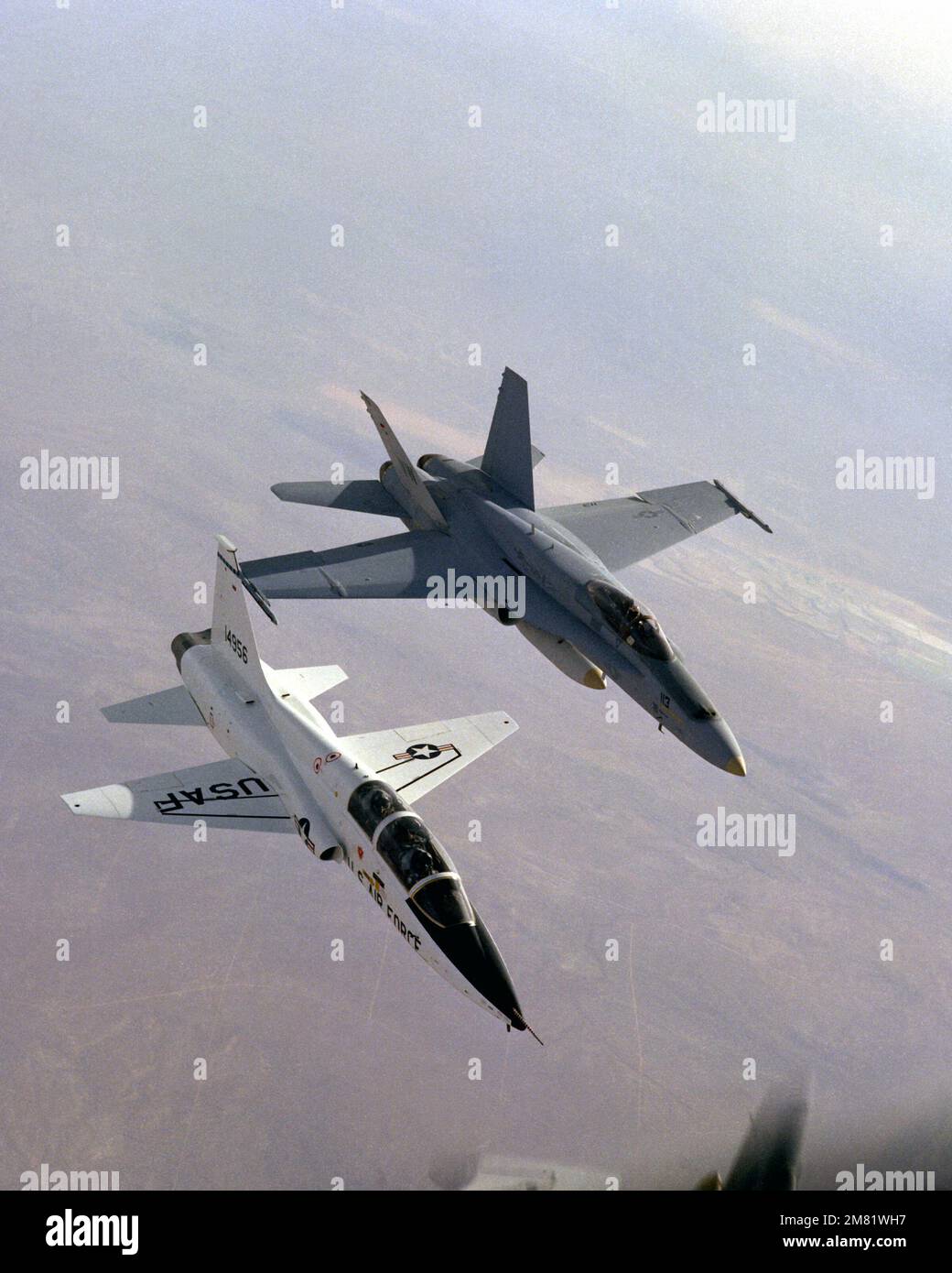An air-to-air right front view of a T-38 Talon aircraft, left, and an F/A-18 Hornet. Country ...