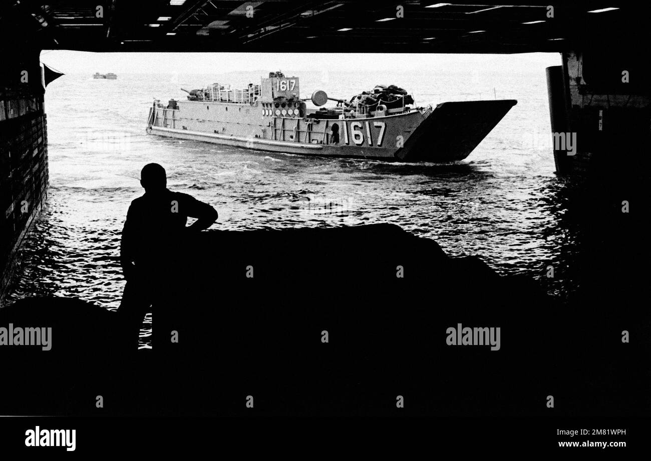 A crewman watches as a utility landing craft (LCU 1617) prepares to ...